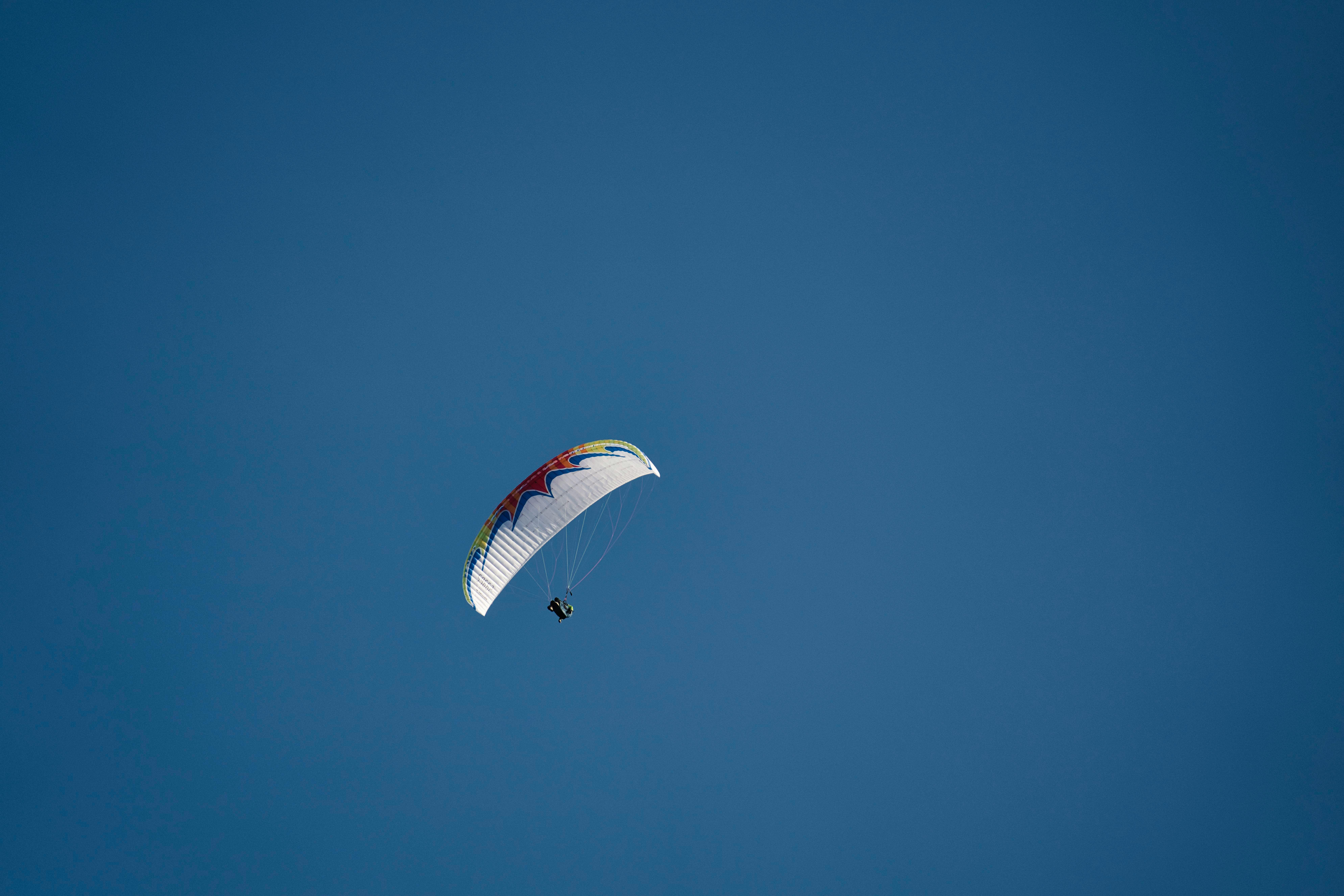 Paraglider Soaring in Clear Blue Sky Adventure · Free Stock Photo