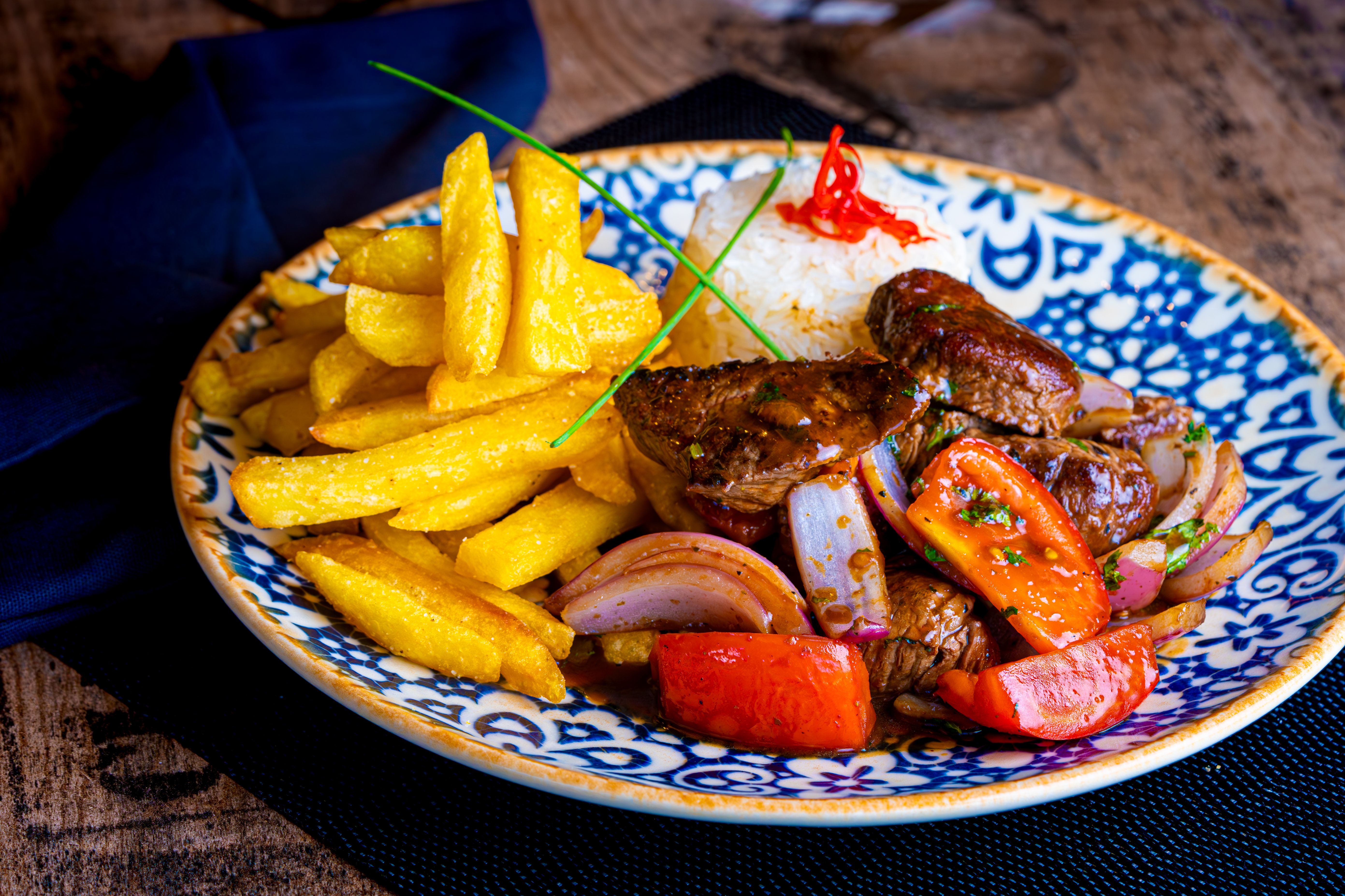 Delicious Lomo Saltado with Fries and Rice on Plate · Free Stock Photo