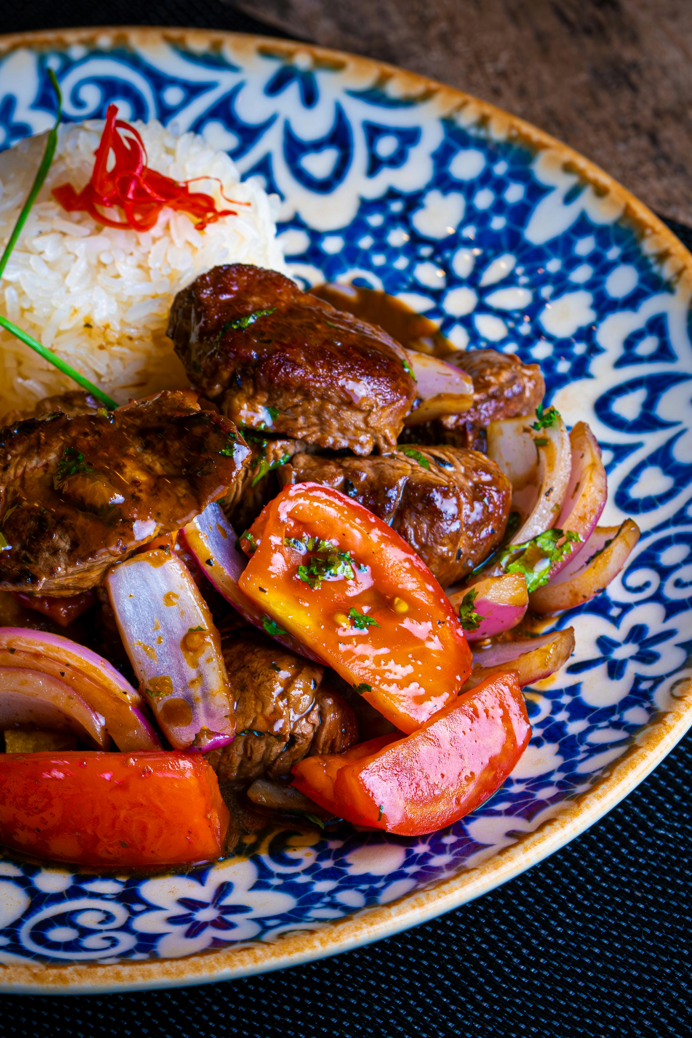 Peruvian Lomo Saltado with Rice in Blue Ceramic Plate · Free Stock Photo
