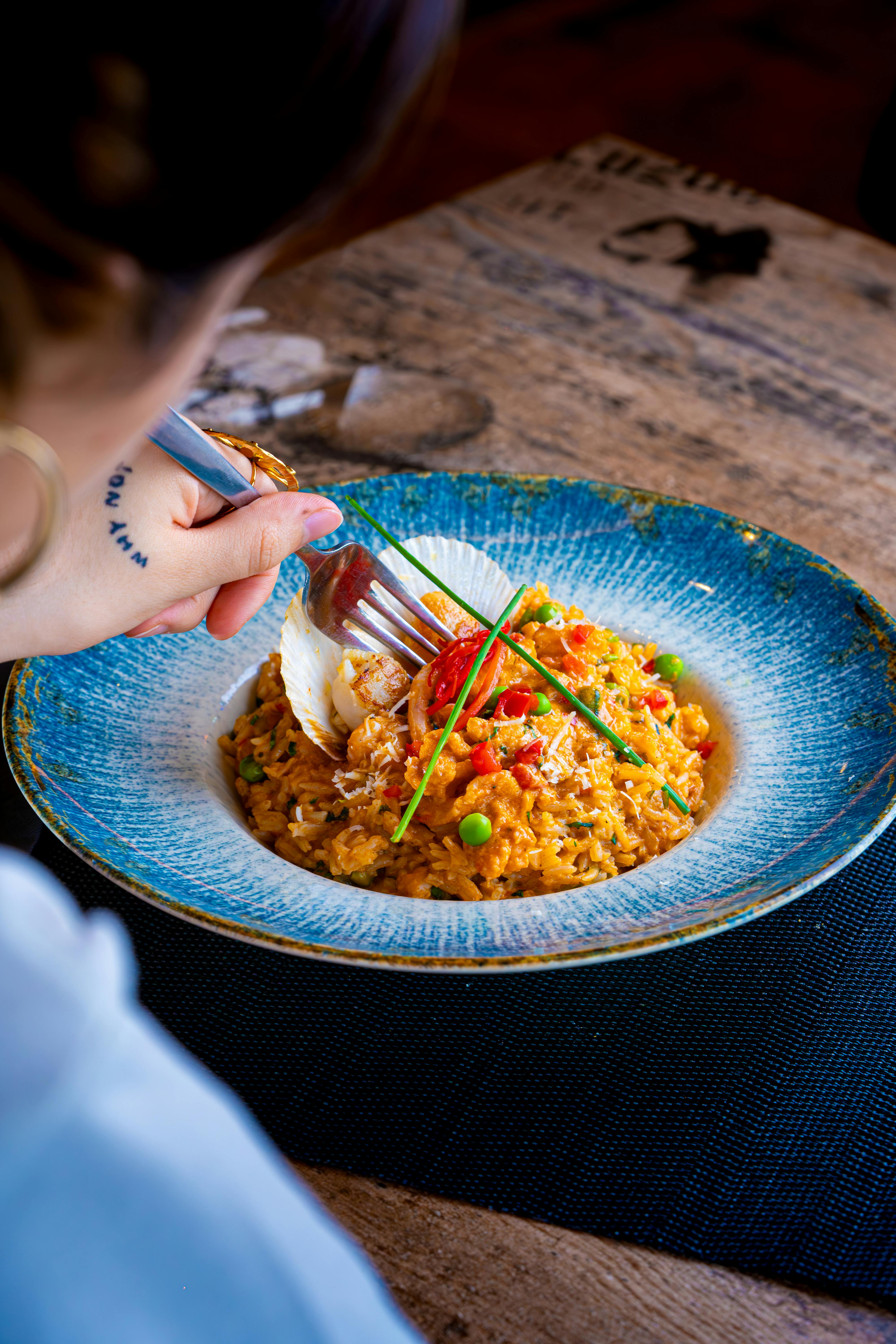 Colorful Seafood Risotto Dish with Fork · Free Stock Photo