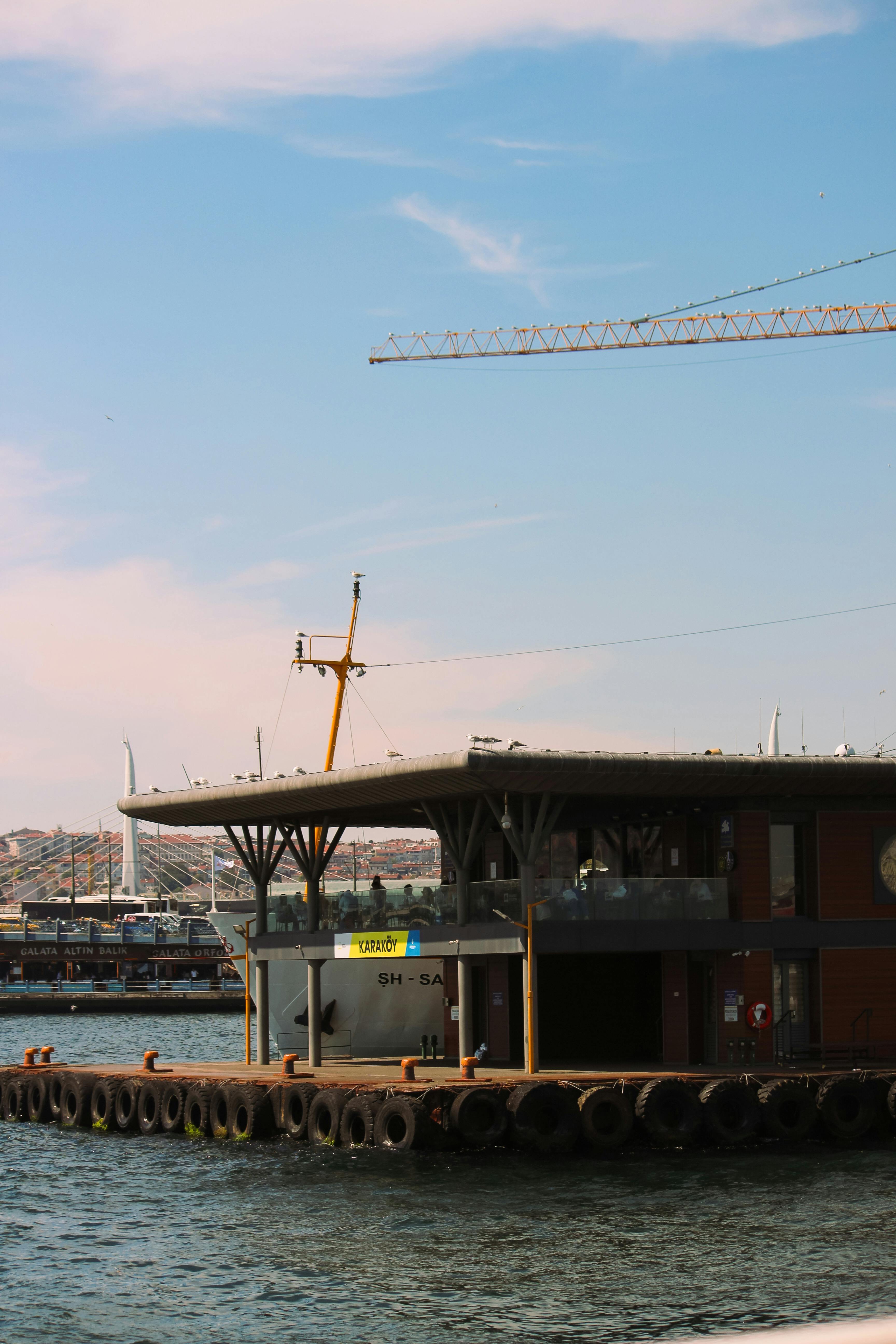 Urban Waterfront with Modern Architecture and Crane · Free Stock Photo