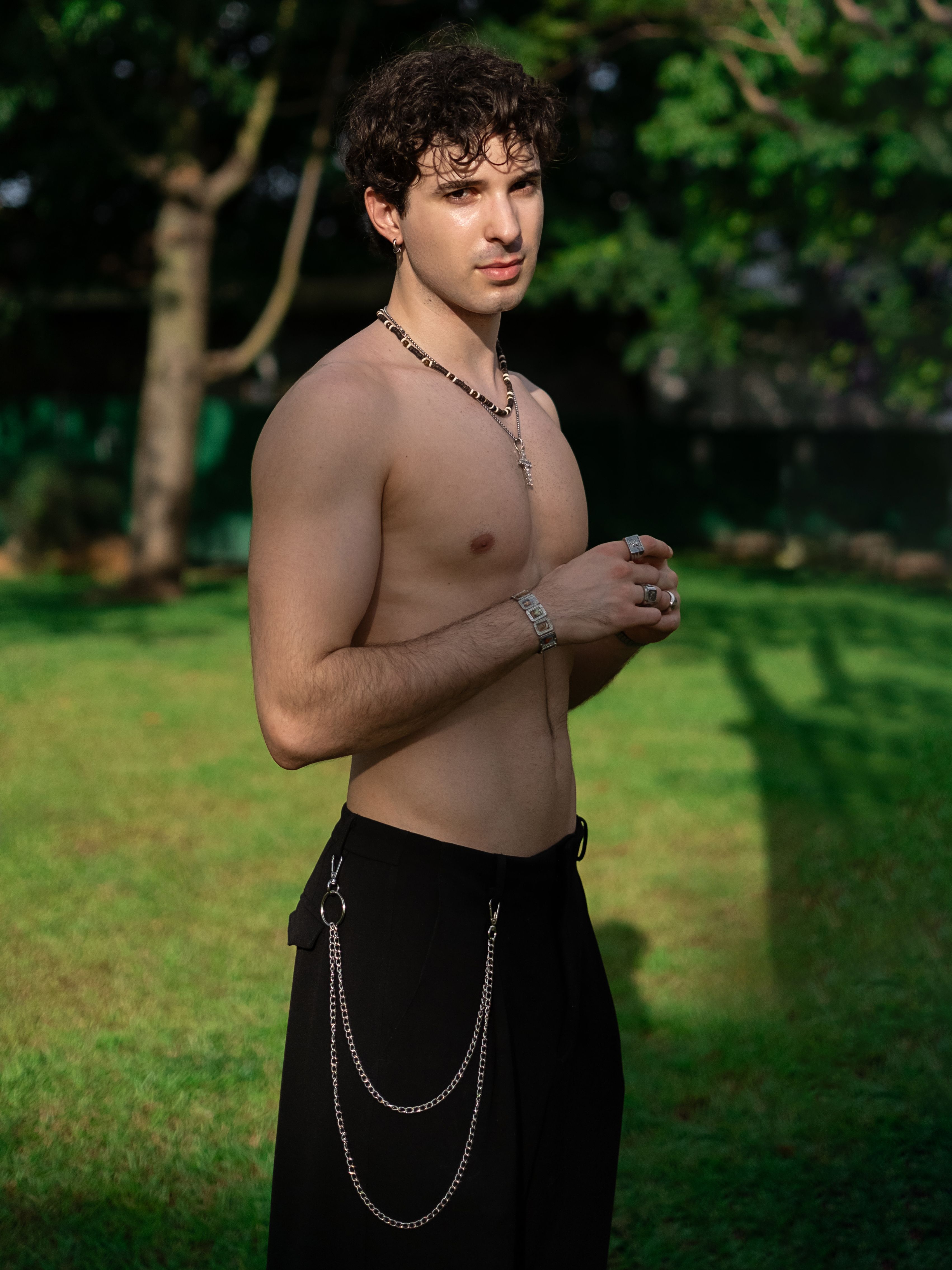 Young Man Posing Outdoors in Sunlight · Free Stock Photo