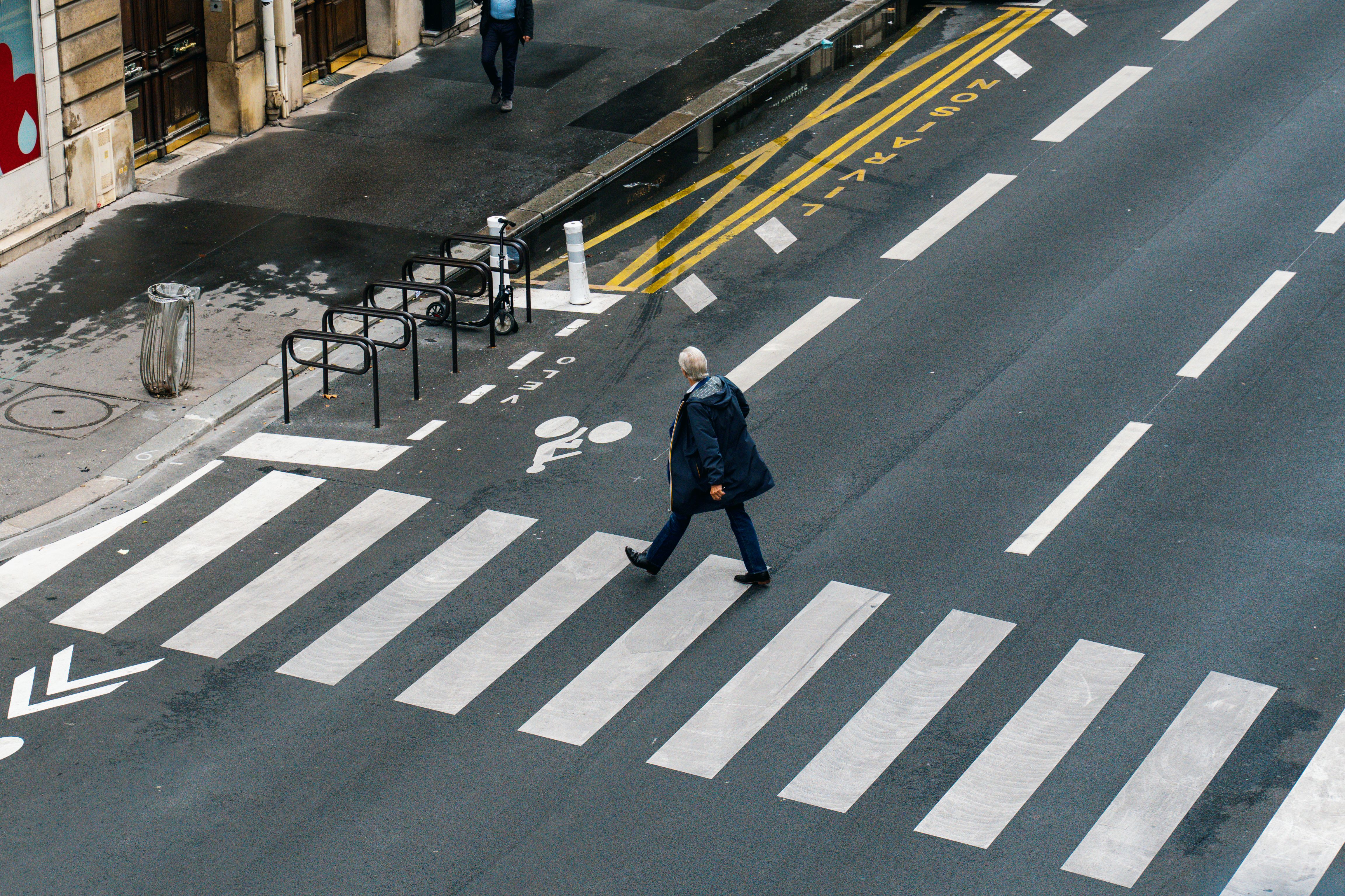 Person crossing zebra crossing on Paris street · Free Stock Photo