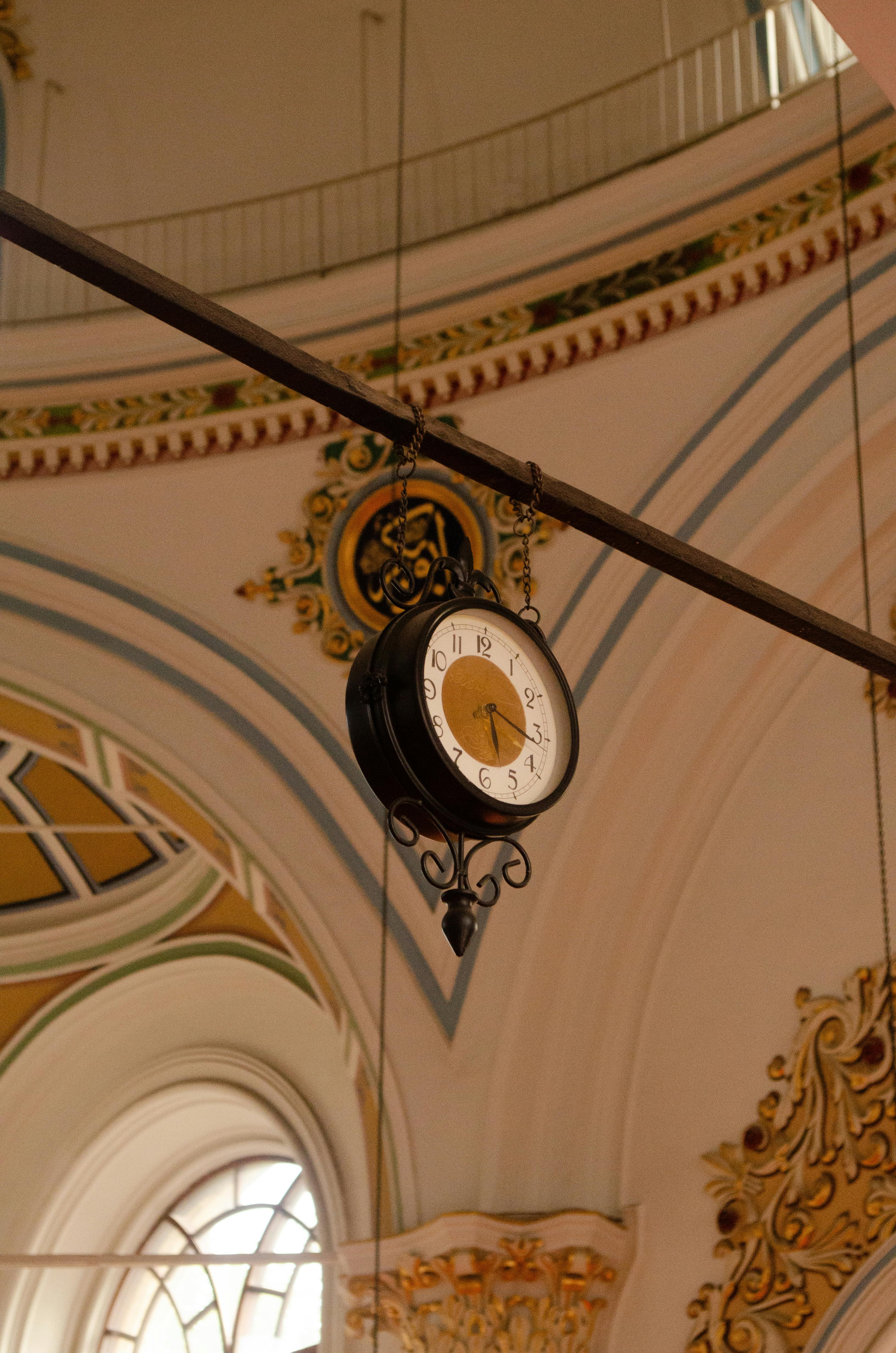 Ornate Analog Clock Hanging in Mosque Interior · Free Stock Photo