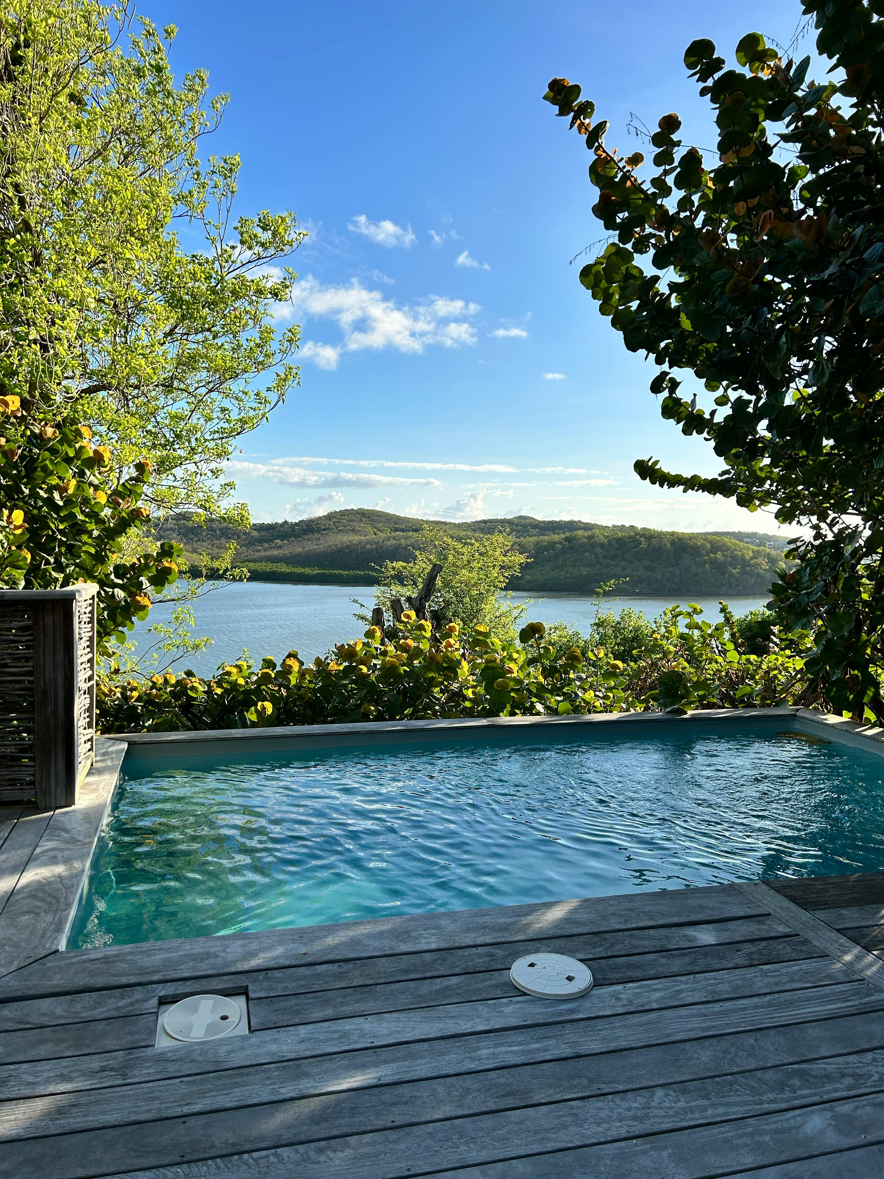 Scenic Poolside View Overlooking Serene Lake · Free Stock Photo