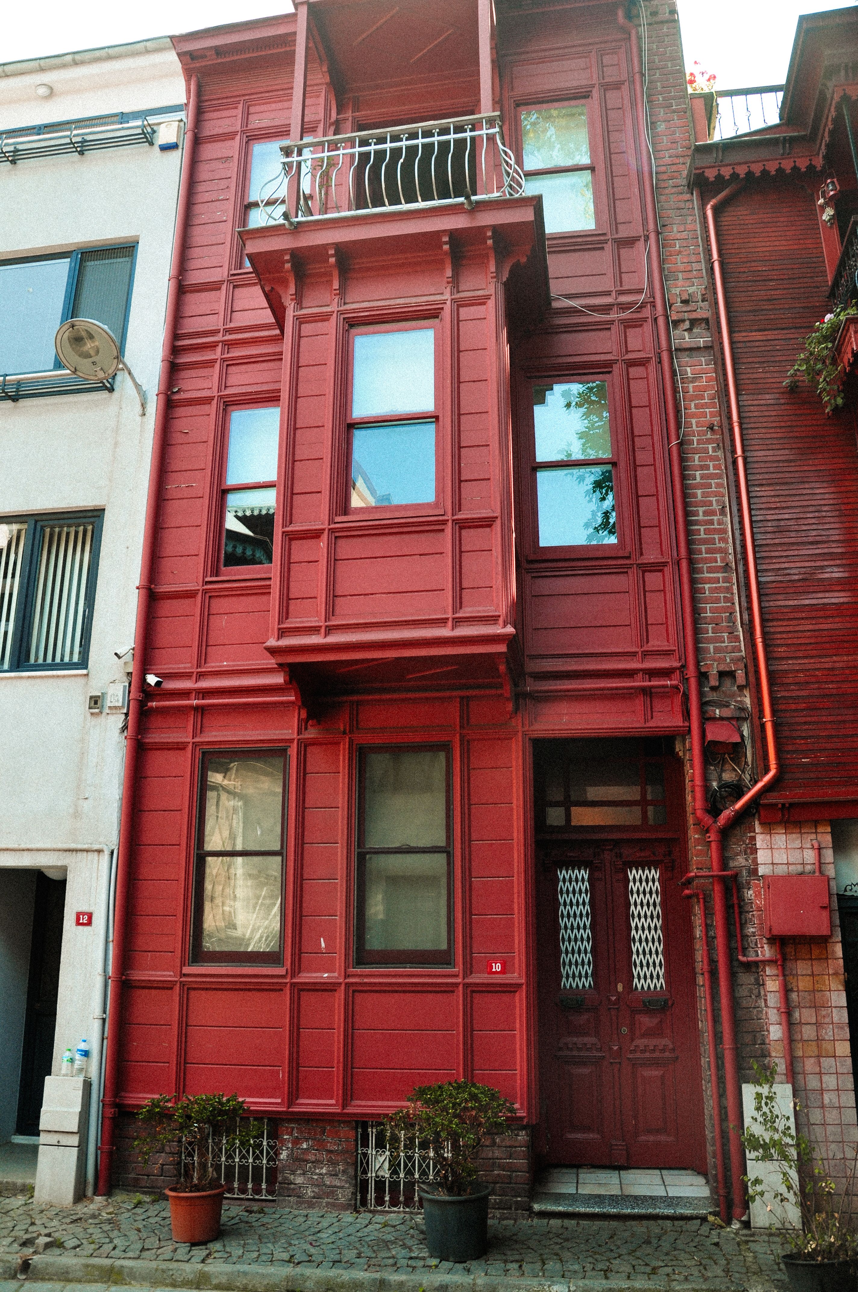 Charming Red Wooden Facade in Urban Setting · Free Stock Photo