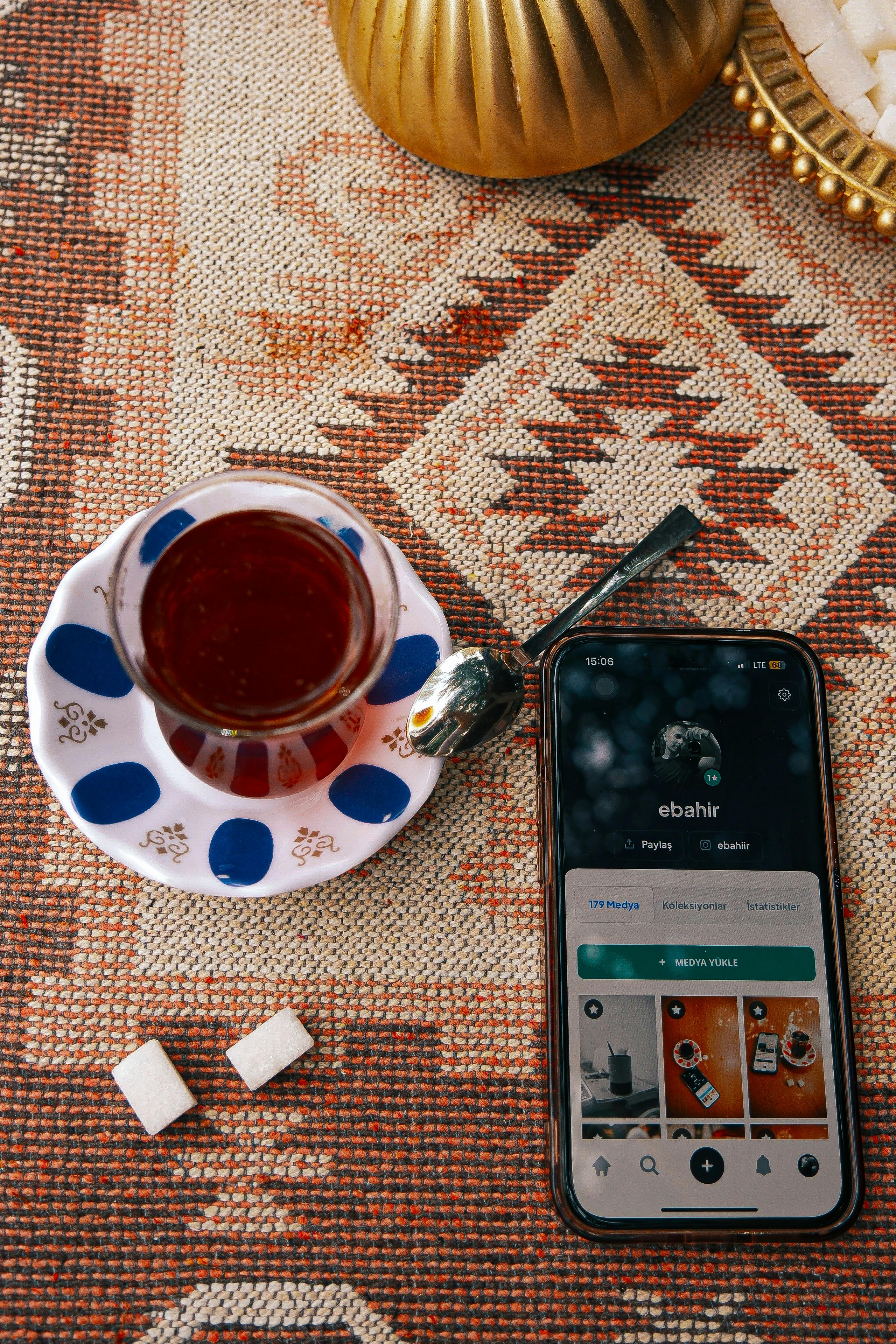 Cozy Tea Setup with Smartphone Device on Rug · Free Stock Photo