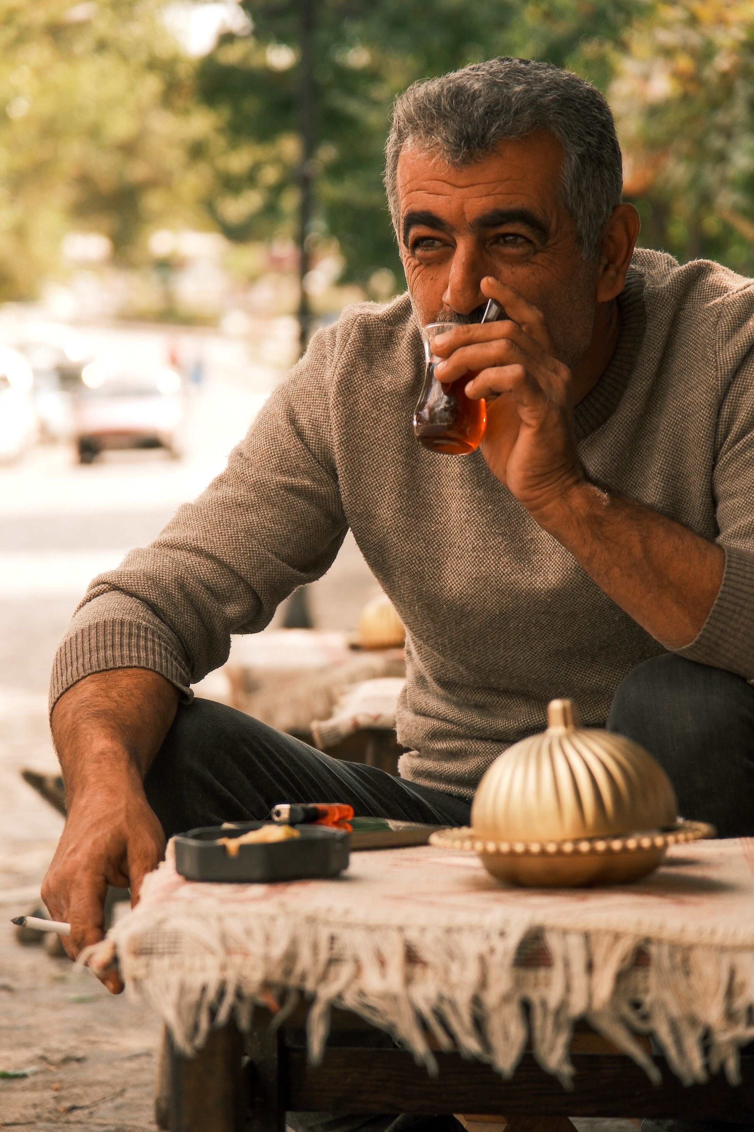 Man savoring traditional tea outdoors · Free Stock Photo
