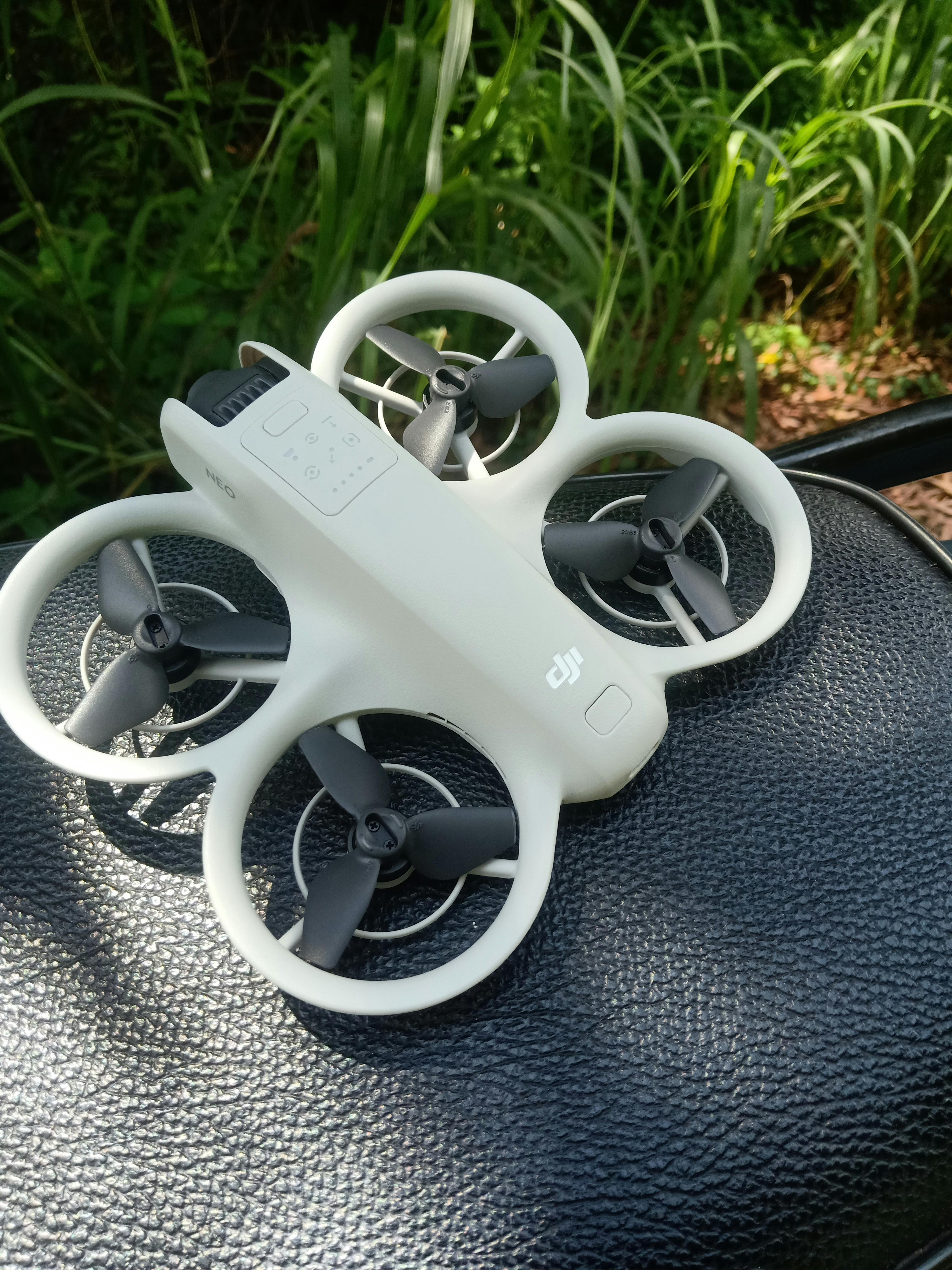 Compact Drone on Black Surface Outdoors · Free Stock Photo