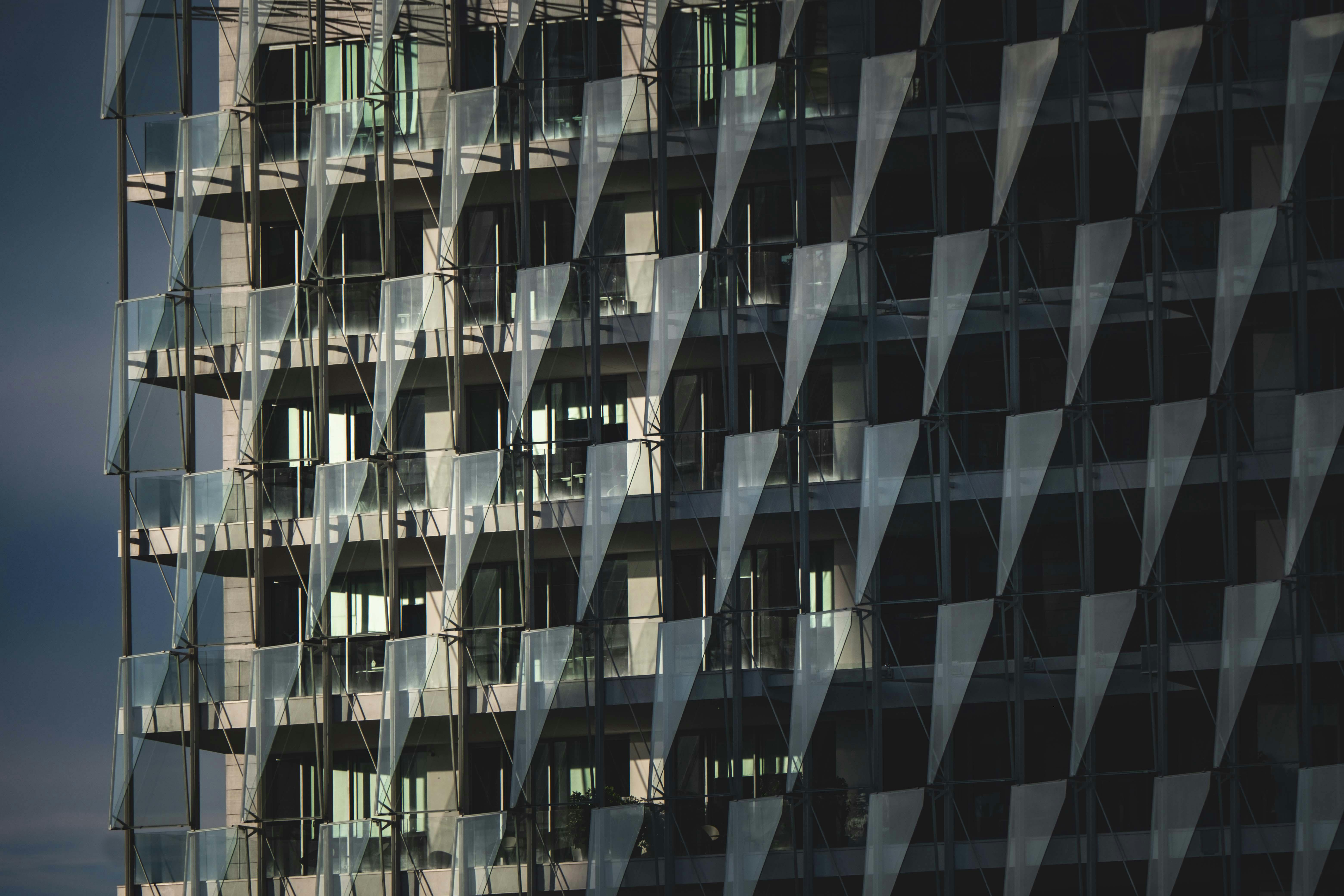 Modern Architectural Building Facade with Glass Panels · Free Stock Photo