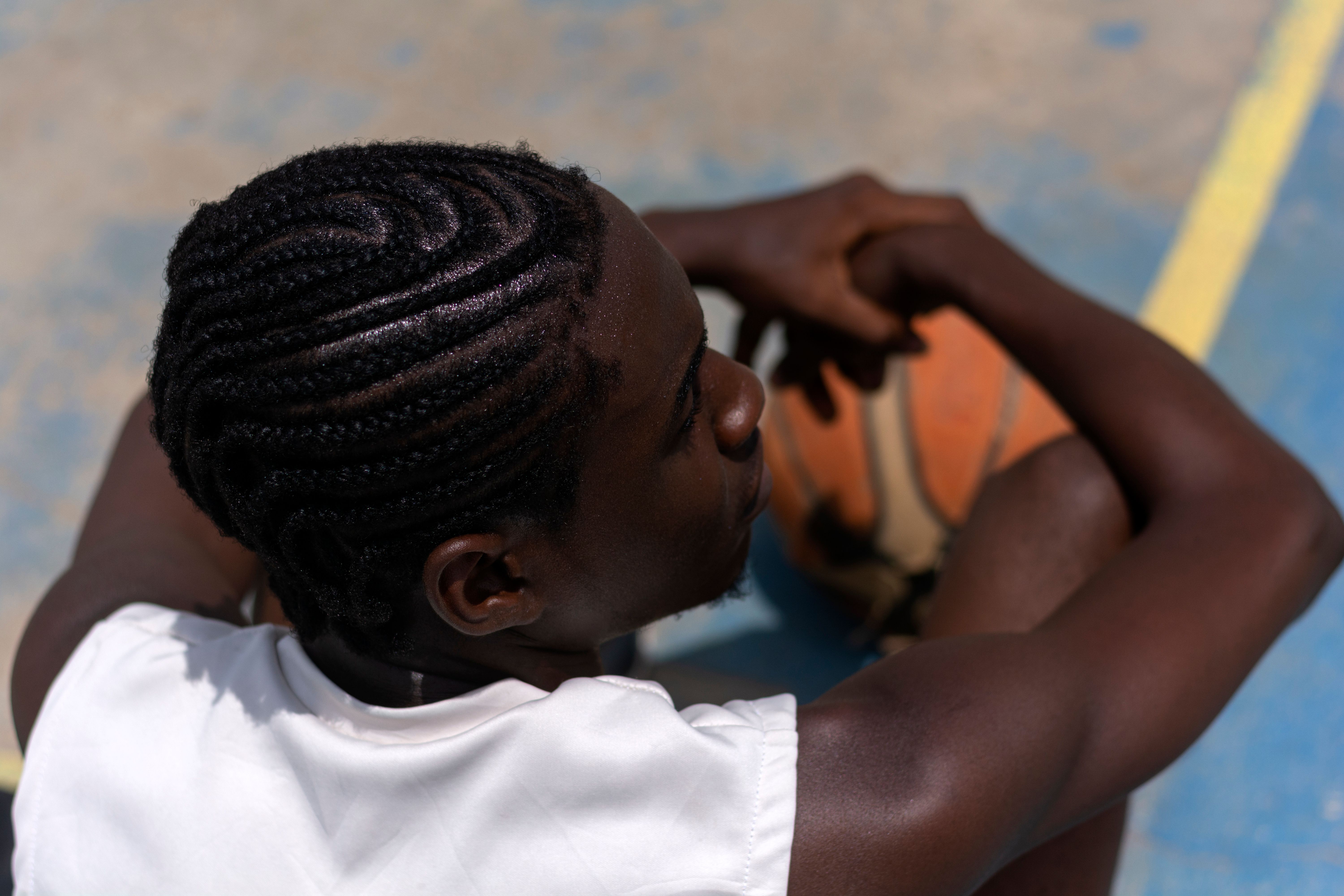 Resting Basketball Player on Outdoor Court · Free Stock Photo