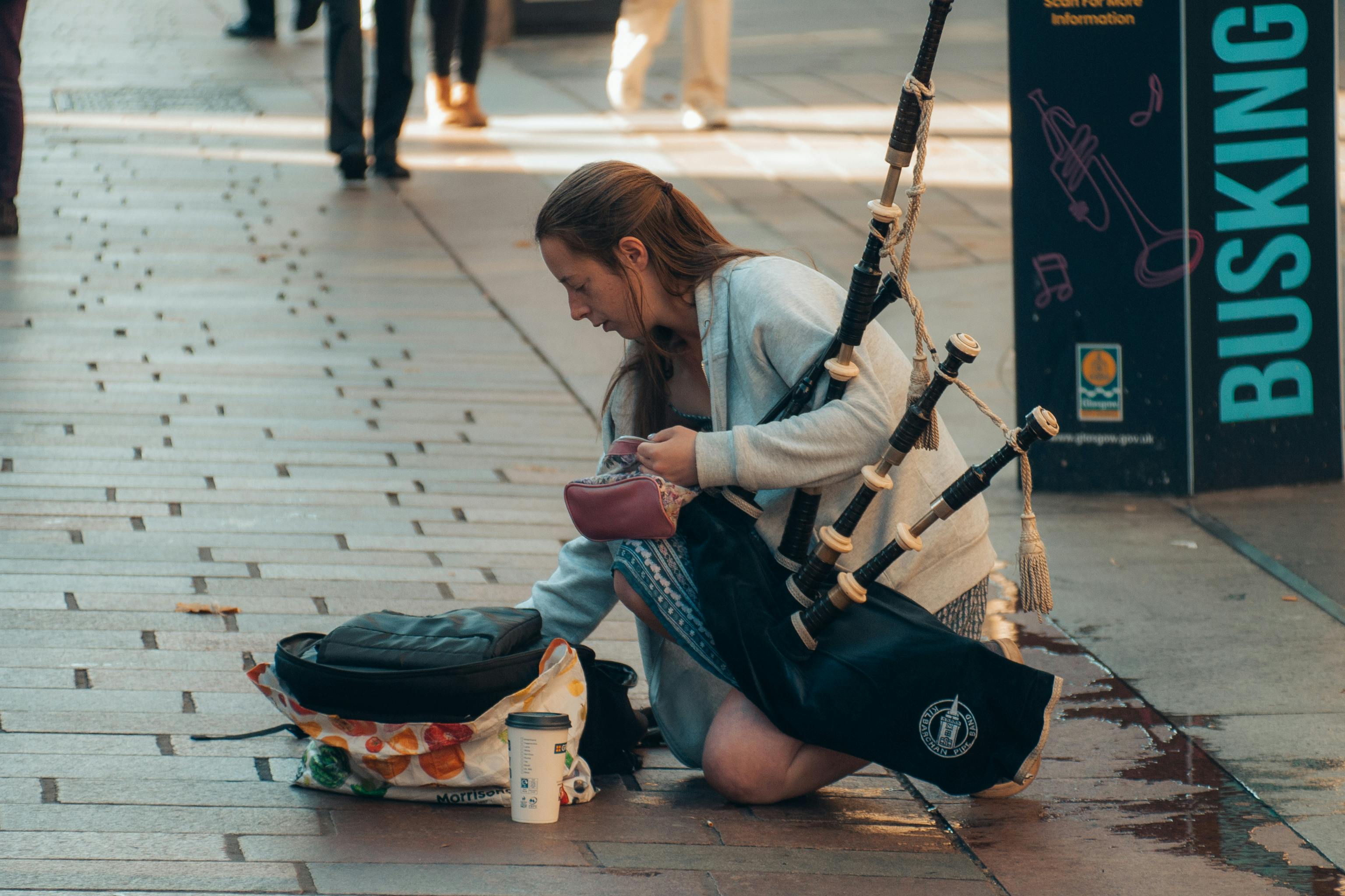 Female Street Performer with Bagpipes Busking · Free Stock Photo
