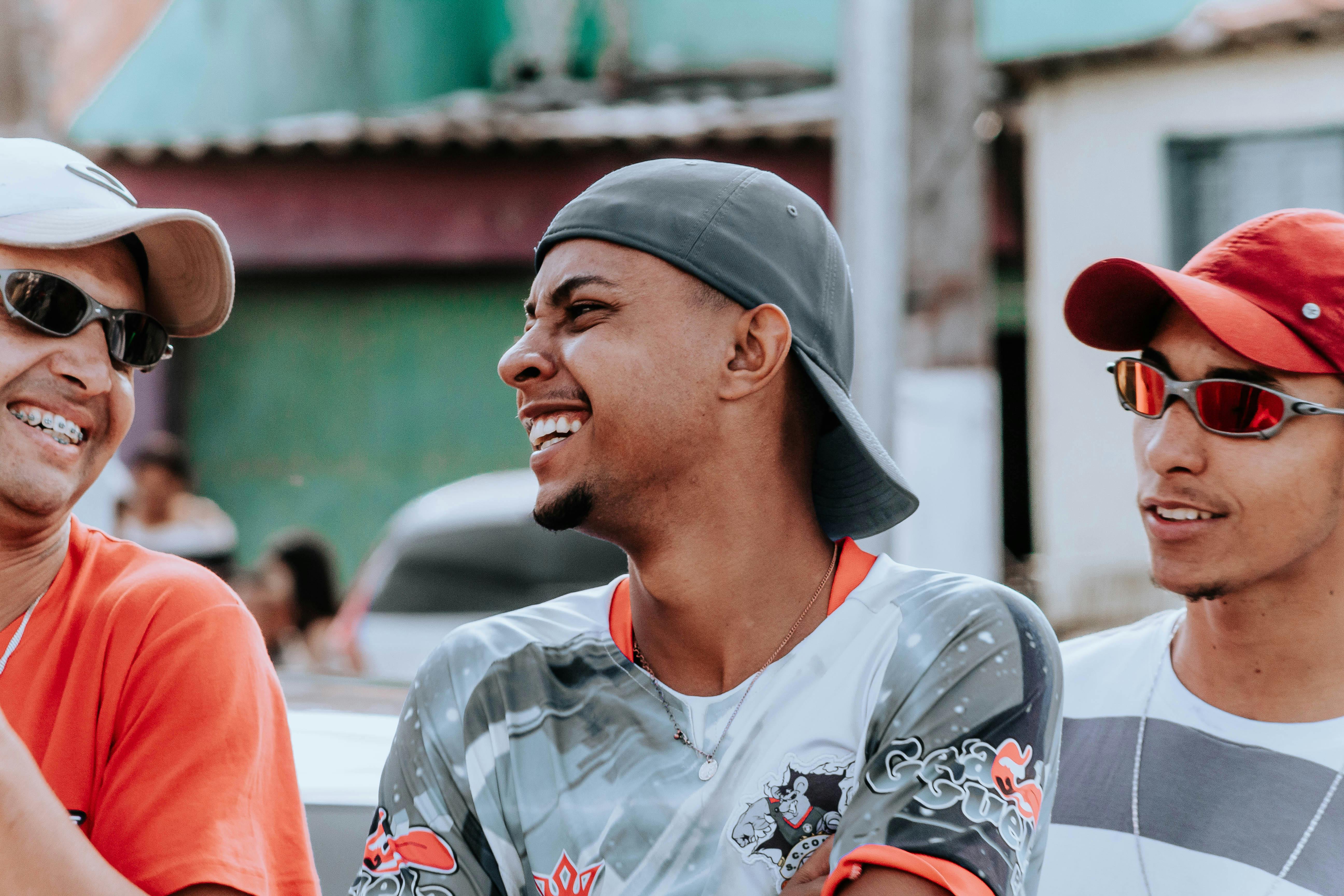 Group of Three Men Smiling Outdoors · Free Stock Photo
