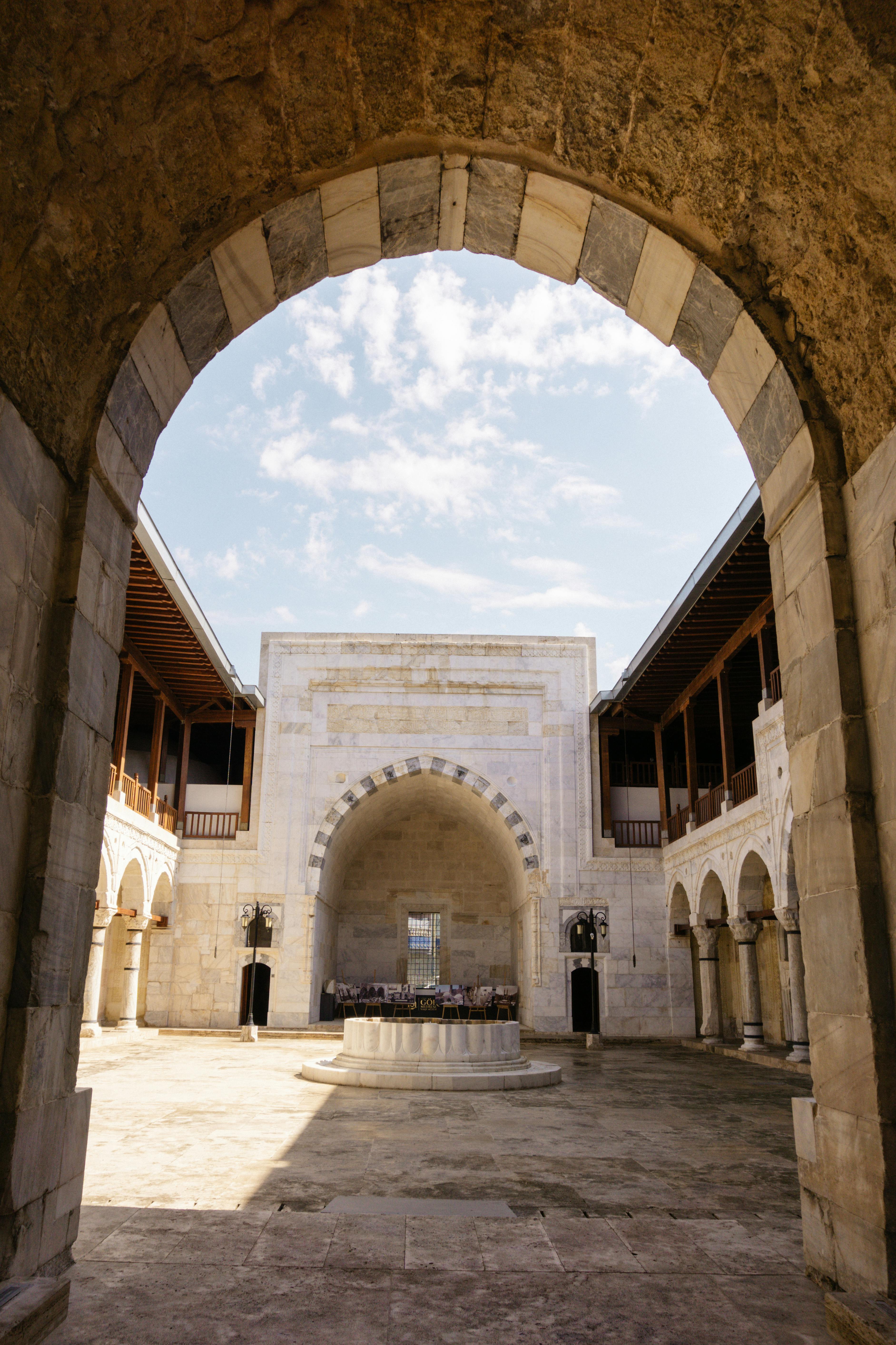 Historic Stone Courtyard with Arched Entrance · Free Stock Photo