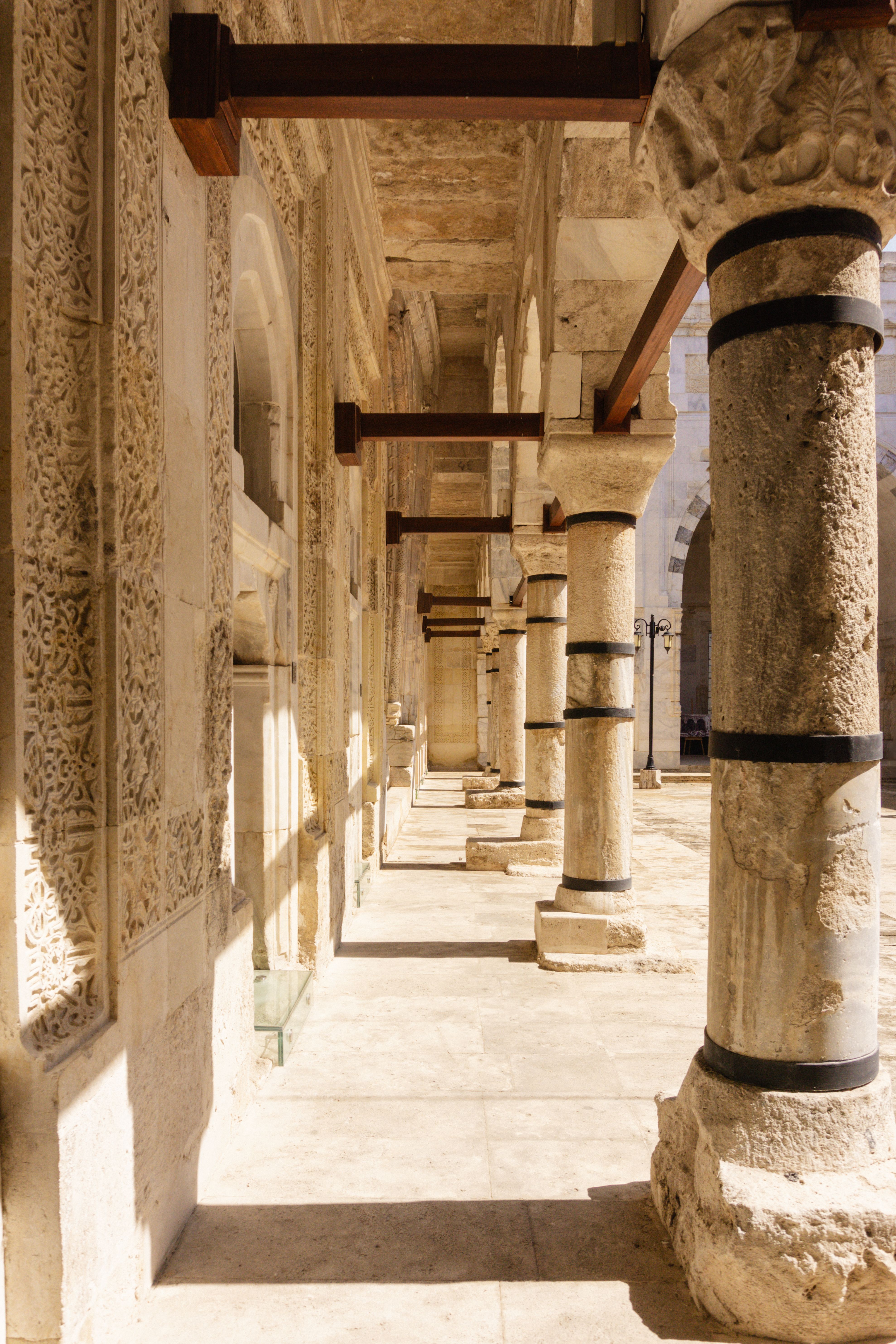 Historic Stone Columns in Sunlit Courtyard · Free Stock Photo