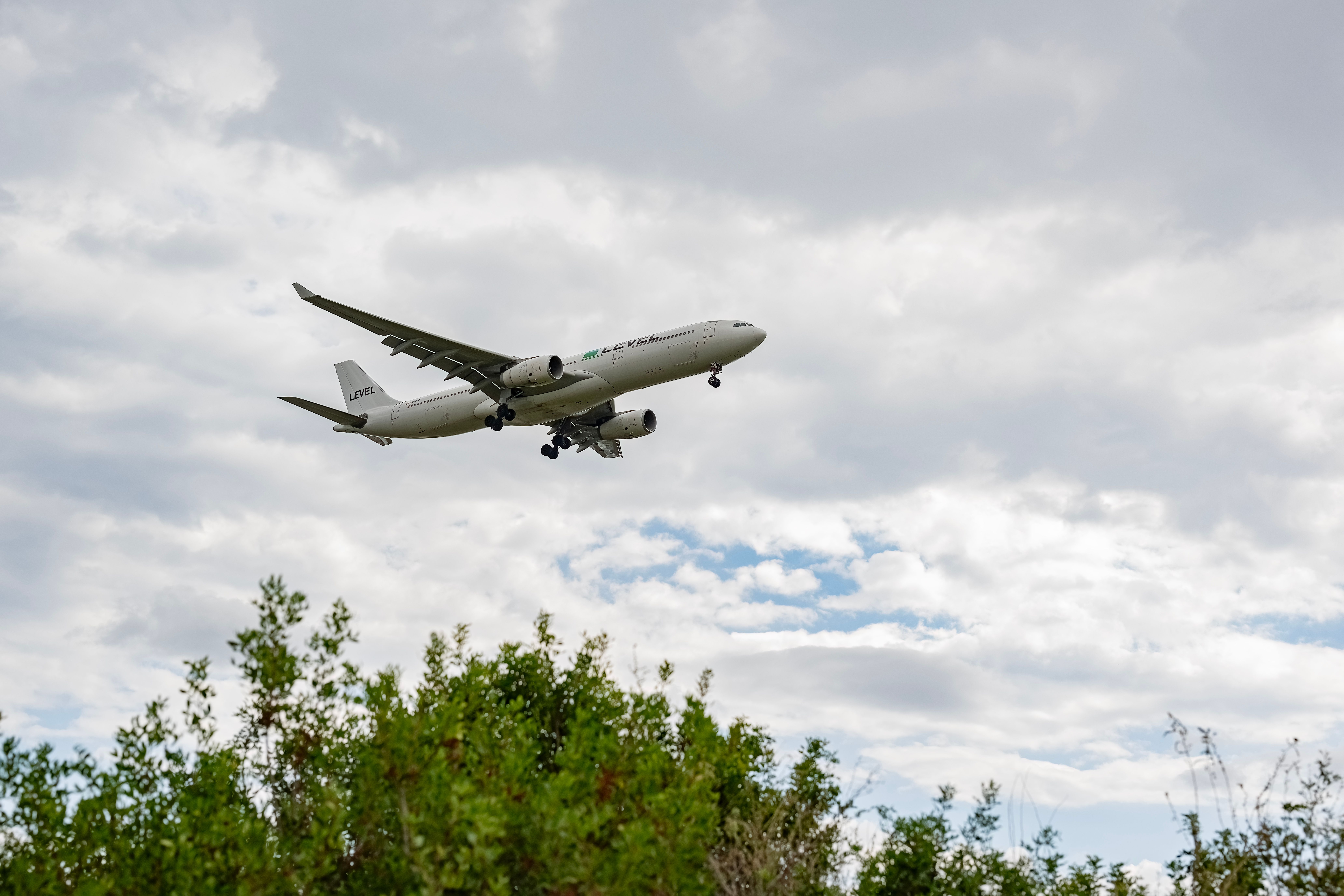 Commercial Airplane Over Barcelona Landscape · Free Stock Photo