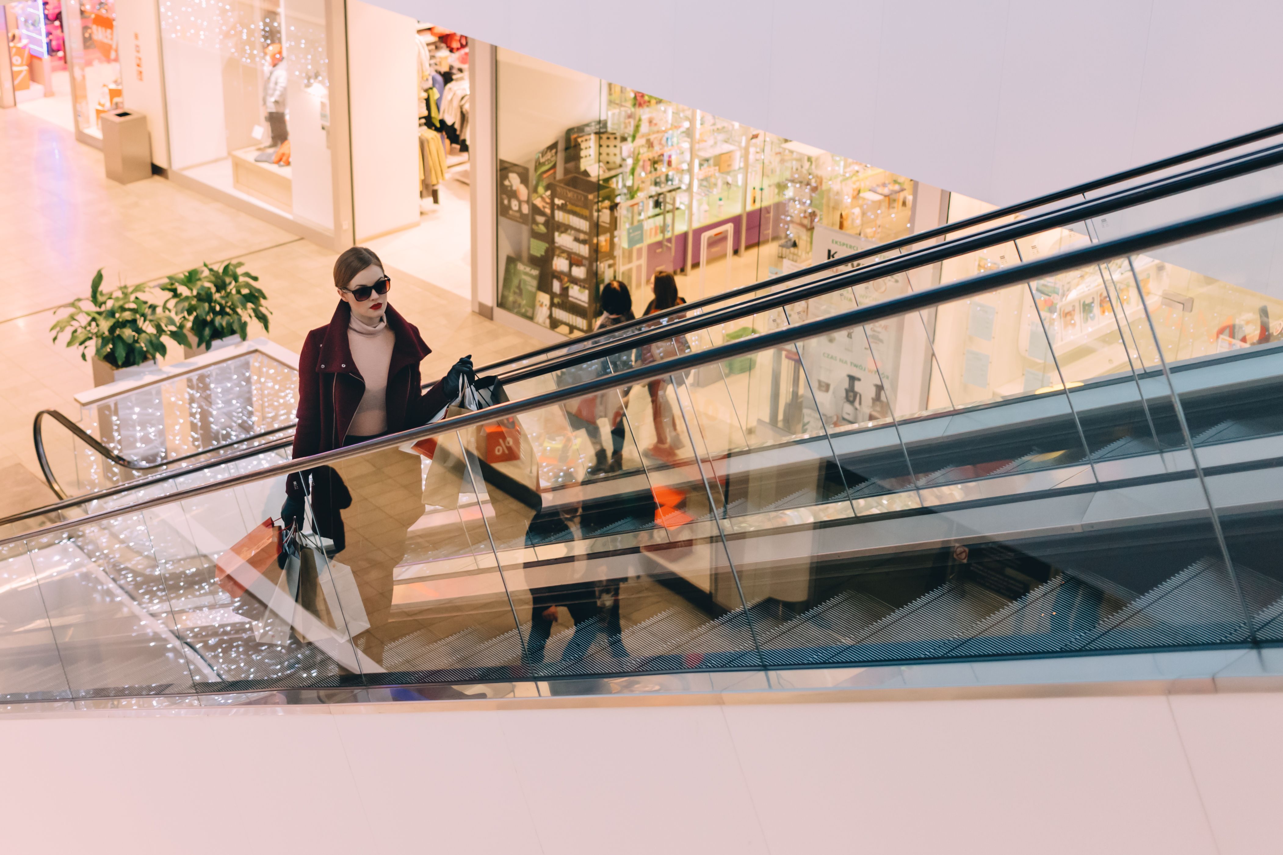 Woman Riding Escalator · Free Stock Photo