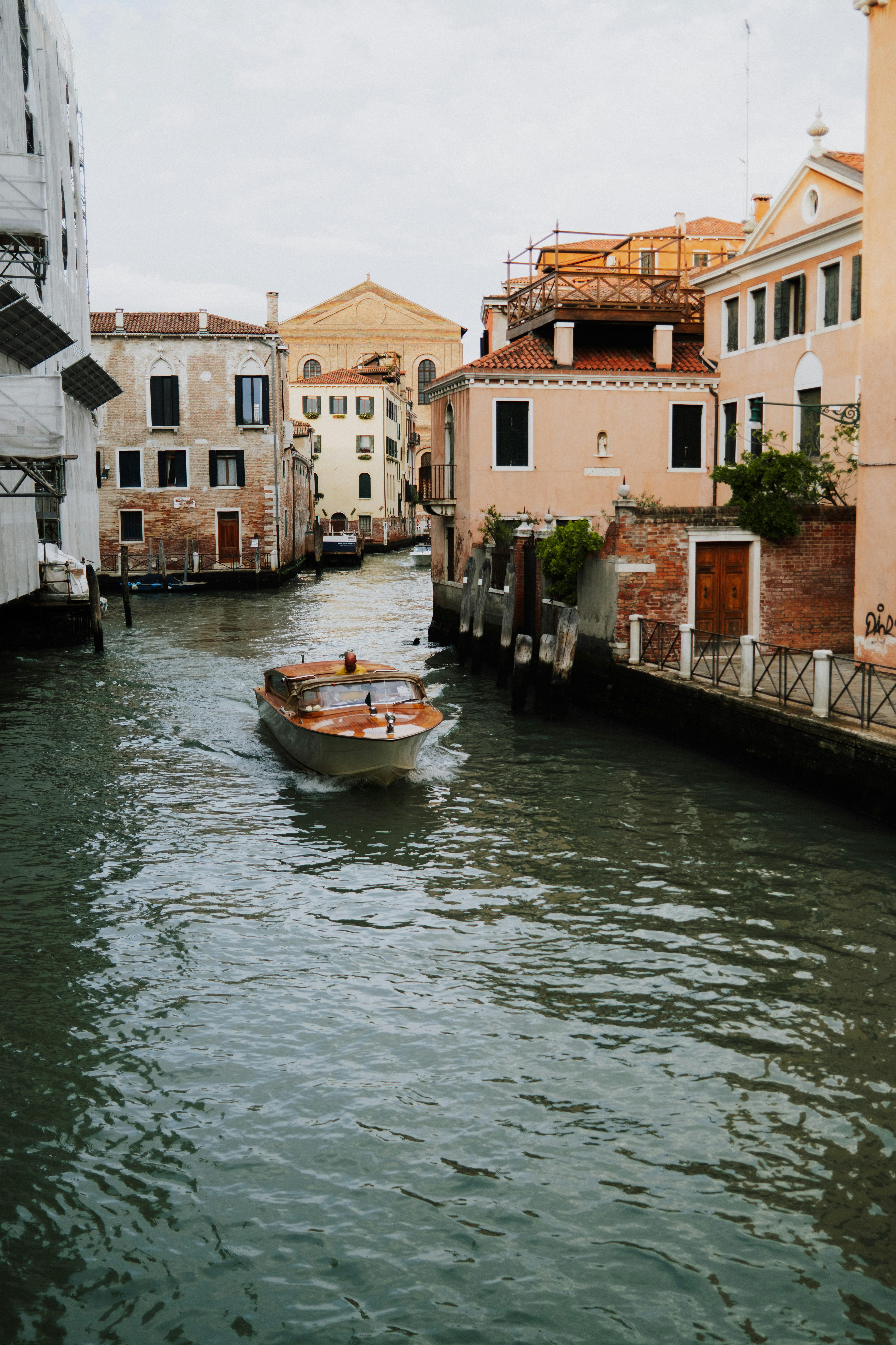 Brown Boat Along The Canals Of Venice · Free Stock Photo