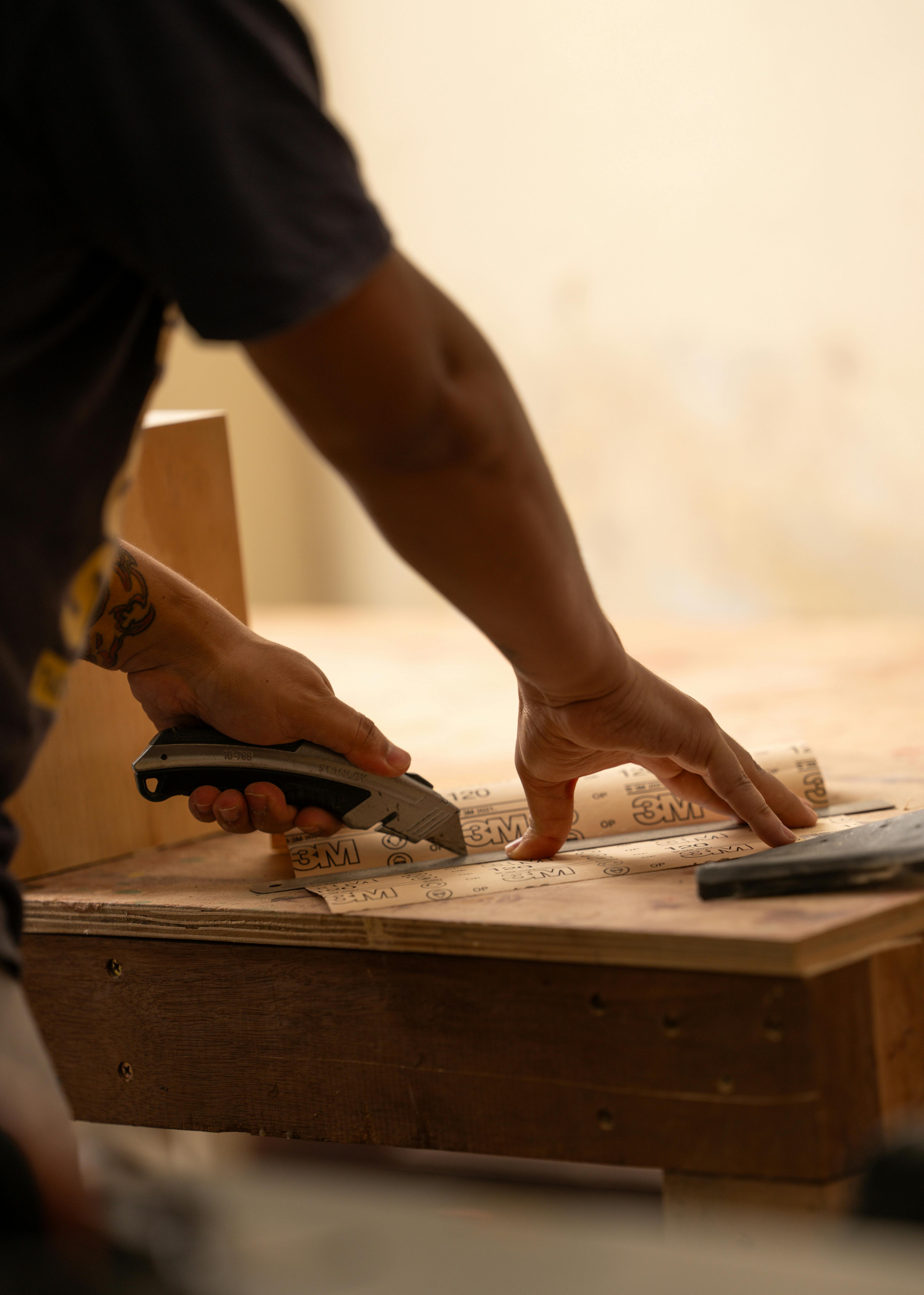 Craftsman Cutting Wood with Precision Tool · Free Stock Photo