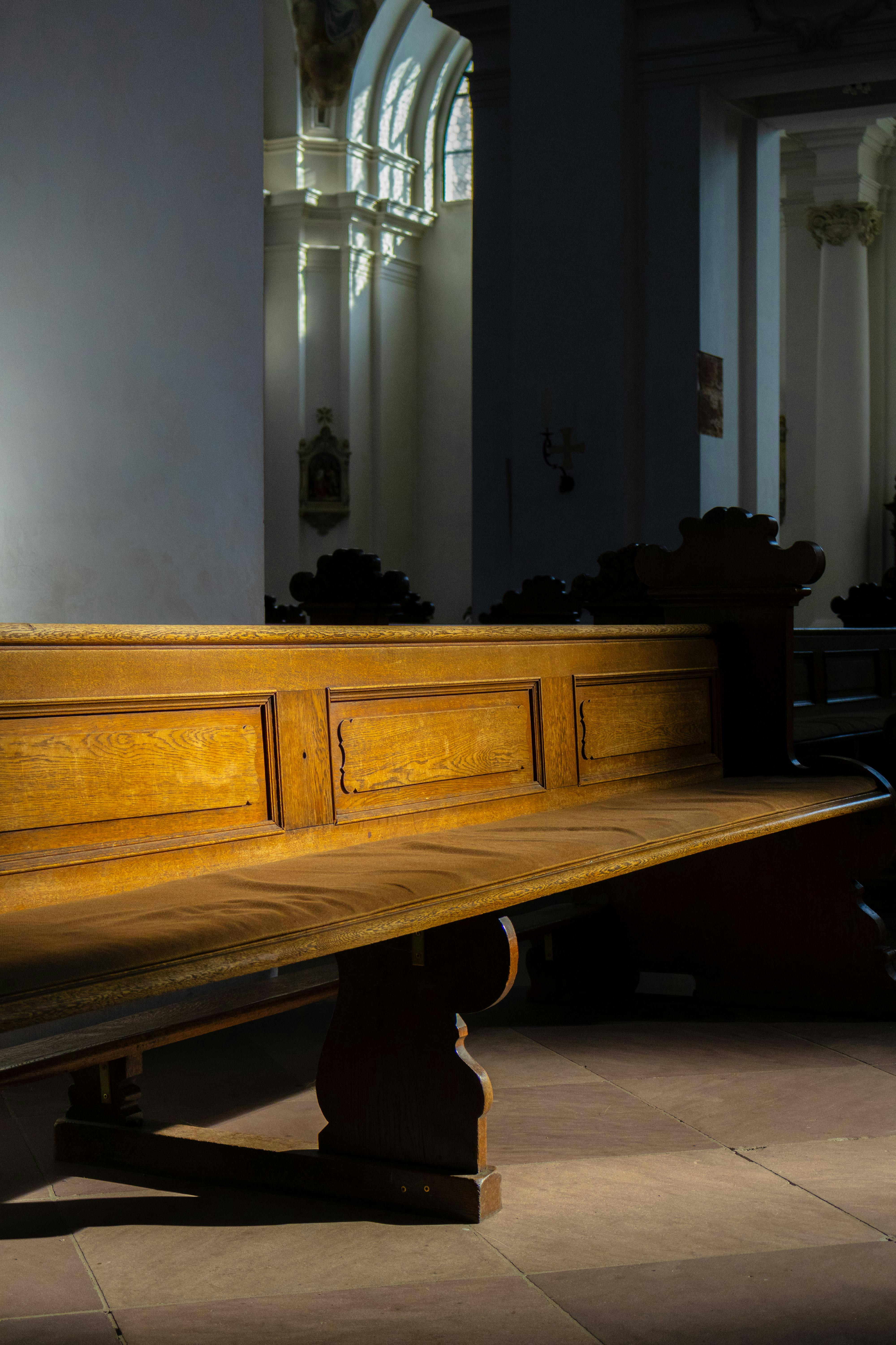Classic Church Pew in Sunlit Cathedral Interior · Free Stock Photo