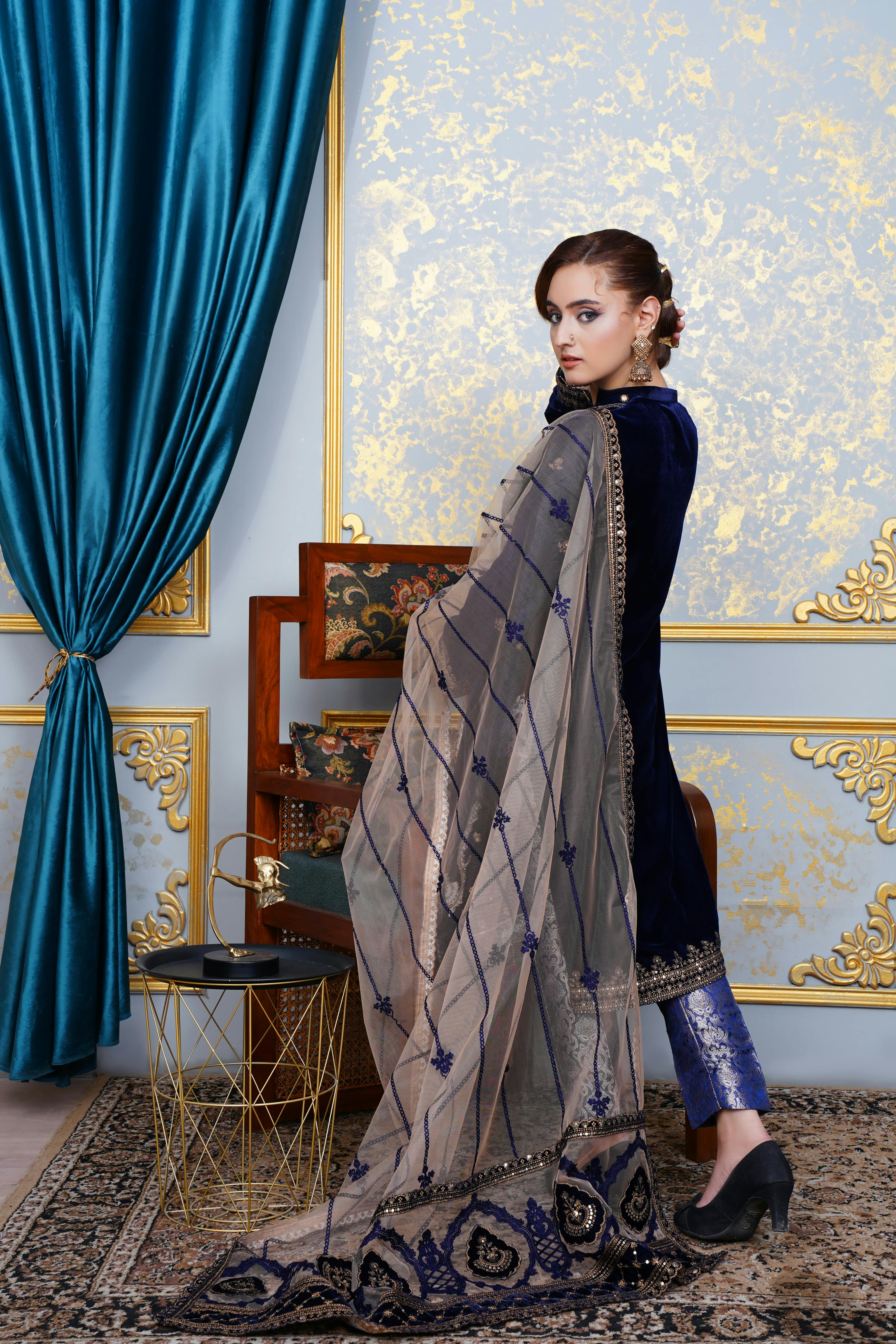 Elegant Woman Posing in Ornate Fashion Ensemble · Free Stock Photo