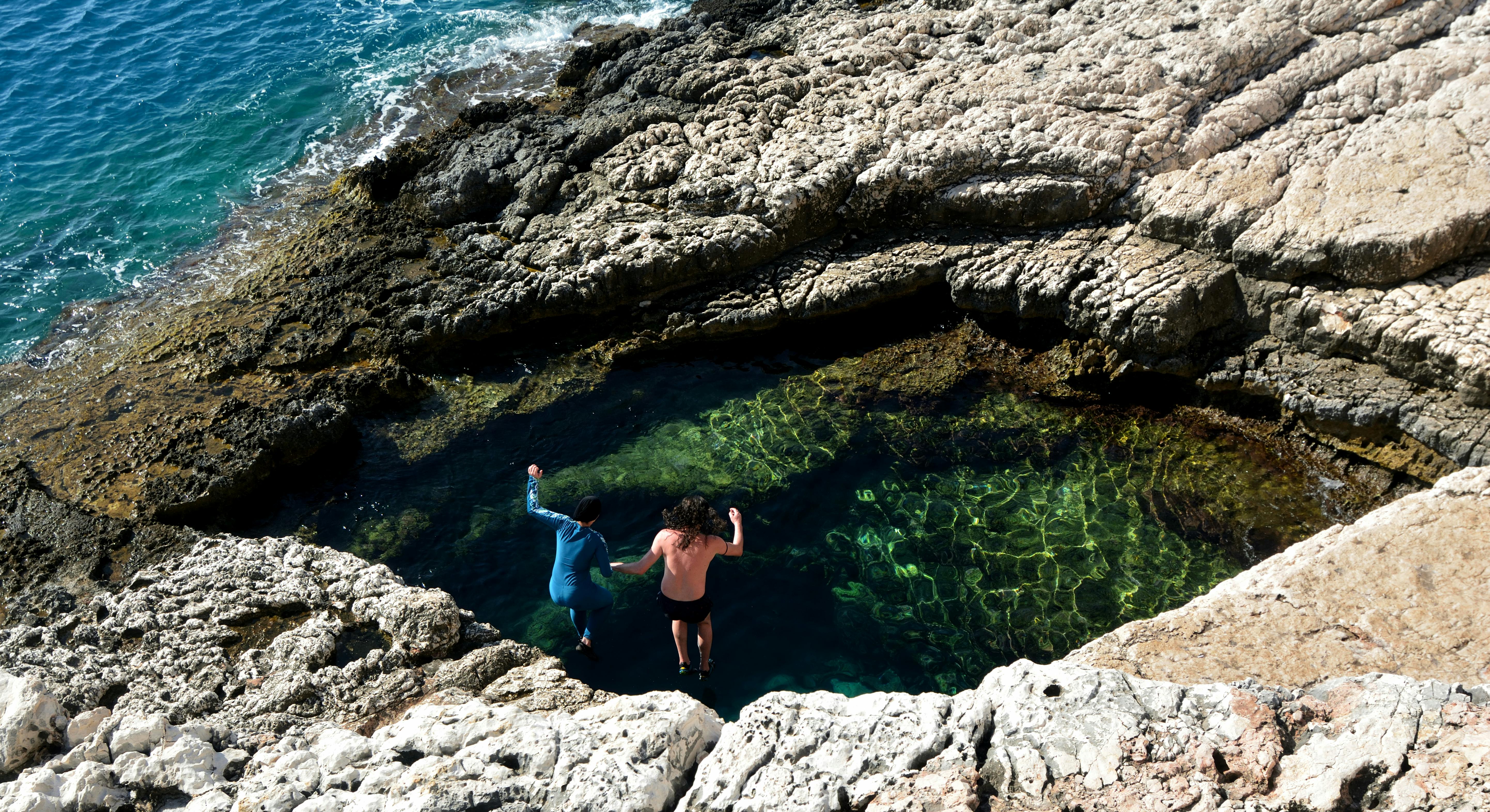 Swimming in Natural Rock Pool in Finike, Türkiye · Free Stock Photo