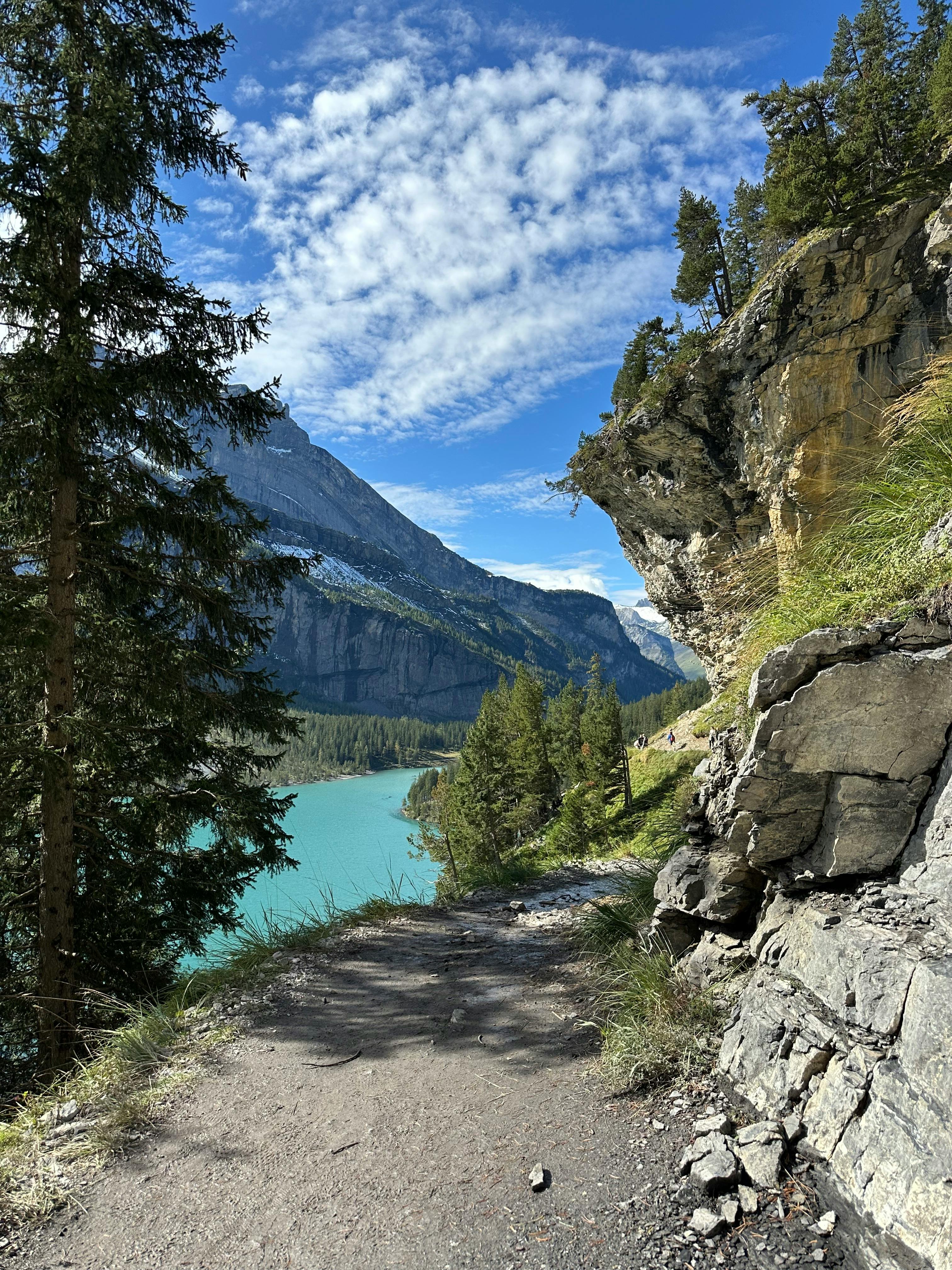 Scenic Alpine Trail Overlooking Lake in Swiss Alps · Free Stock Photo