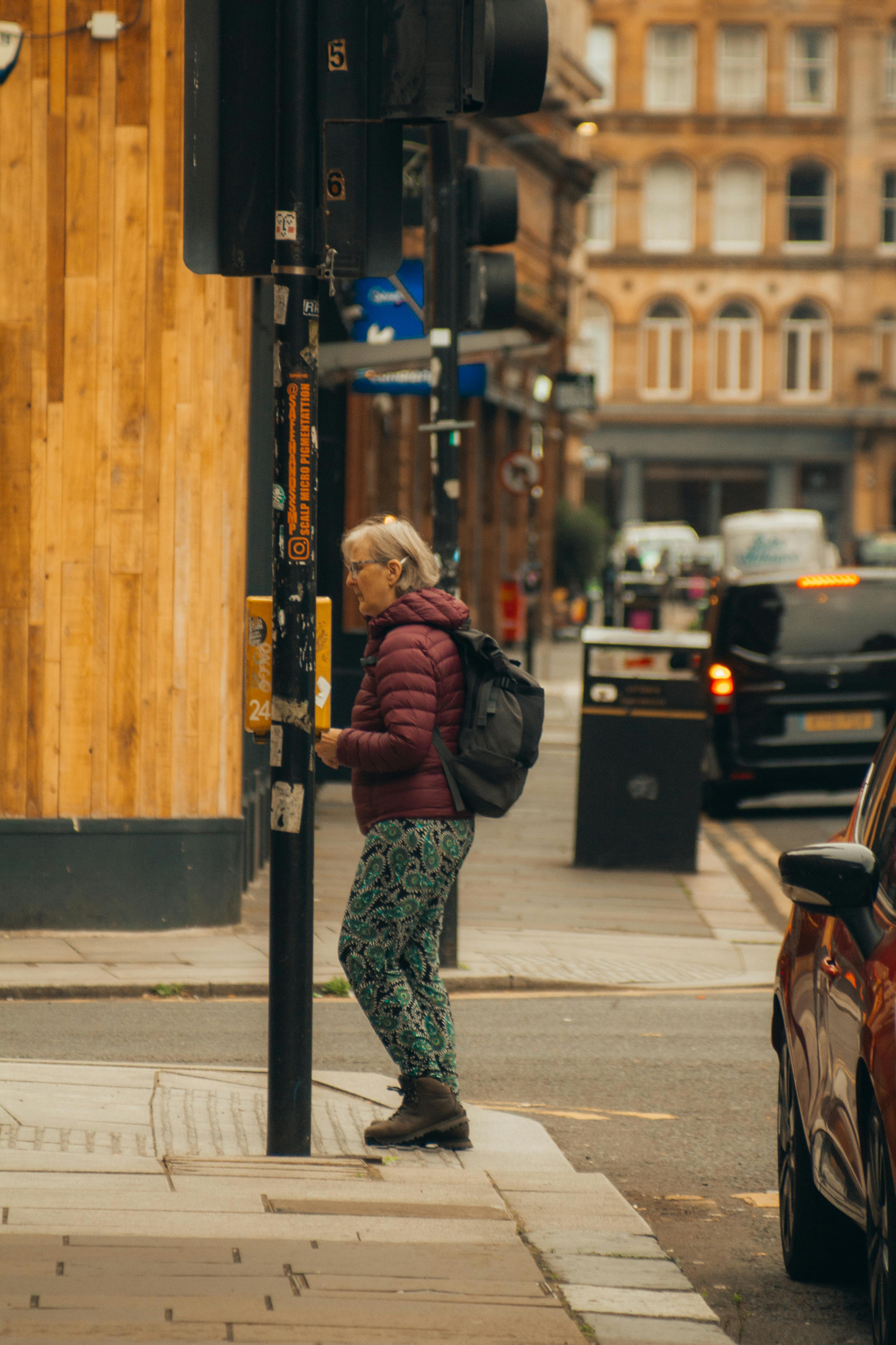 Senior Woman Walking in Urban Street Scene · Free Stock Photo