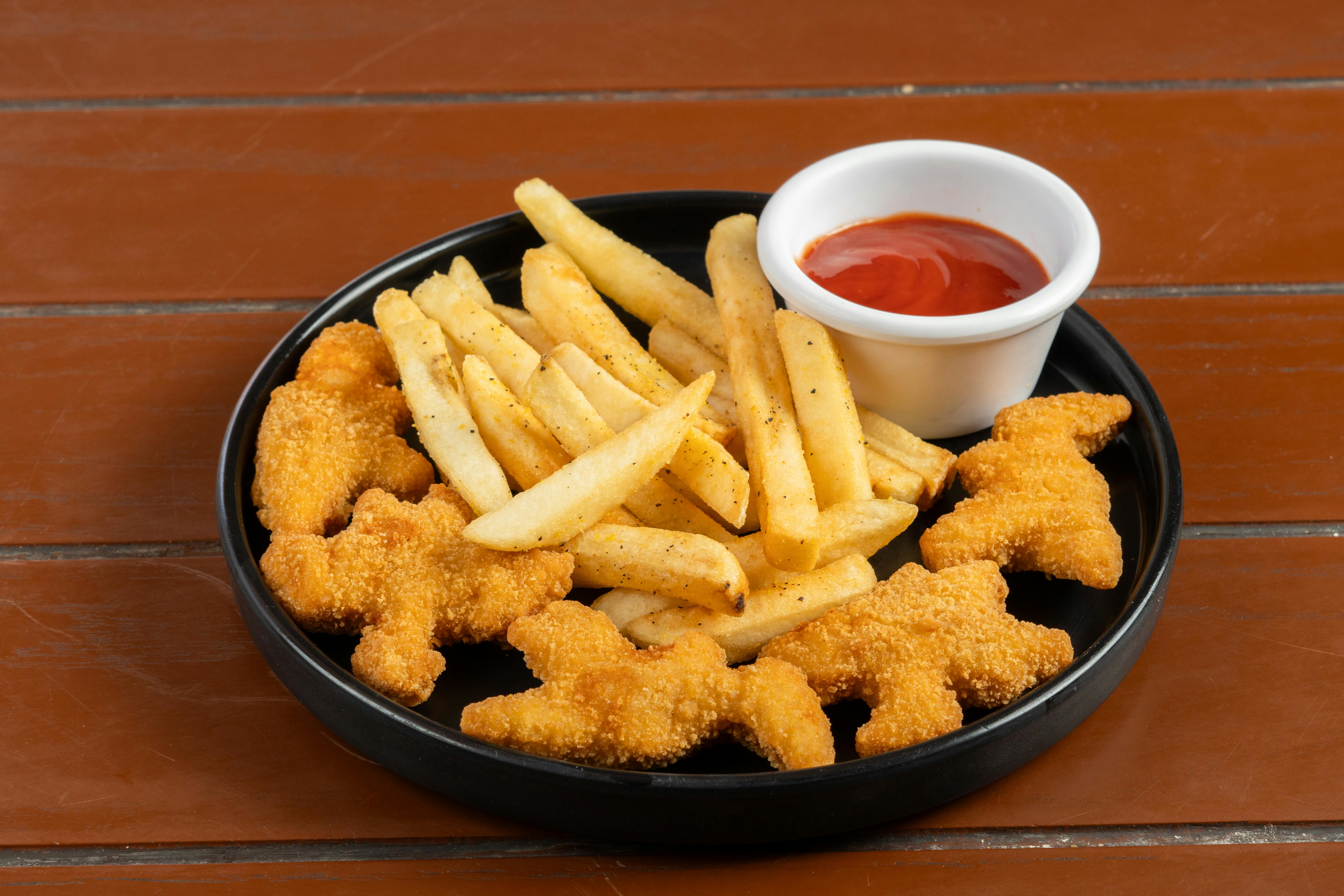 Nuggets De Dinosaures Ludiques Avec Frites Et Ketchup · Photo gratuite