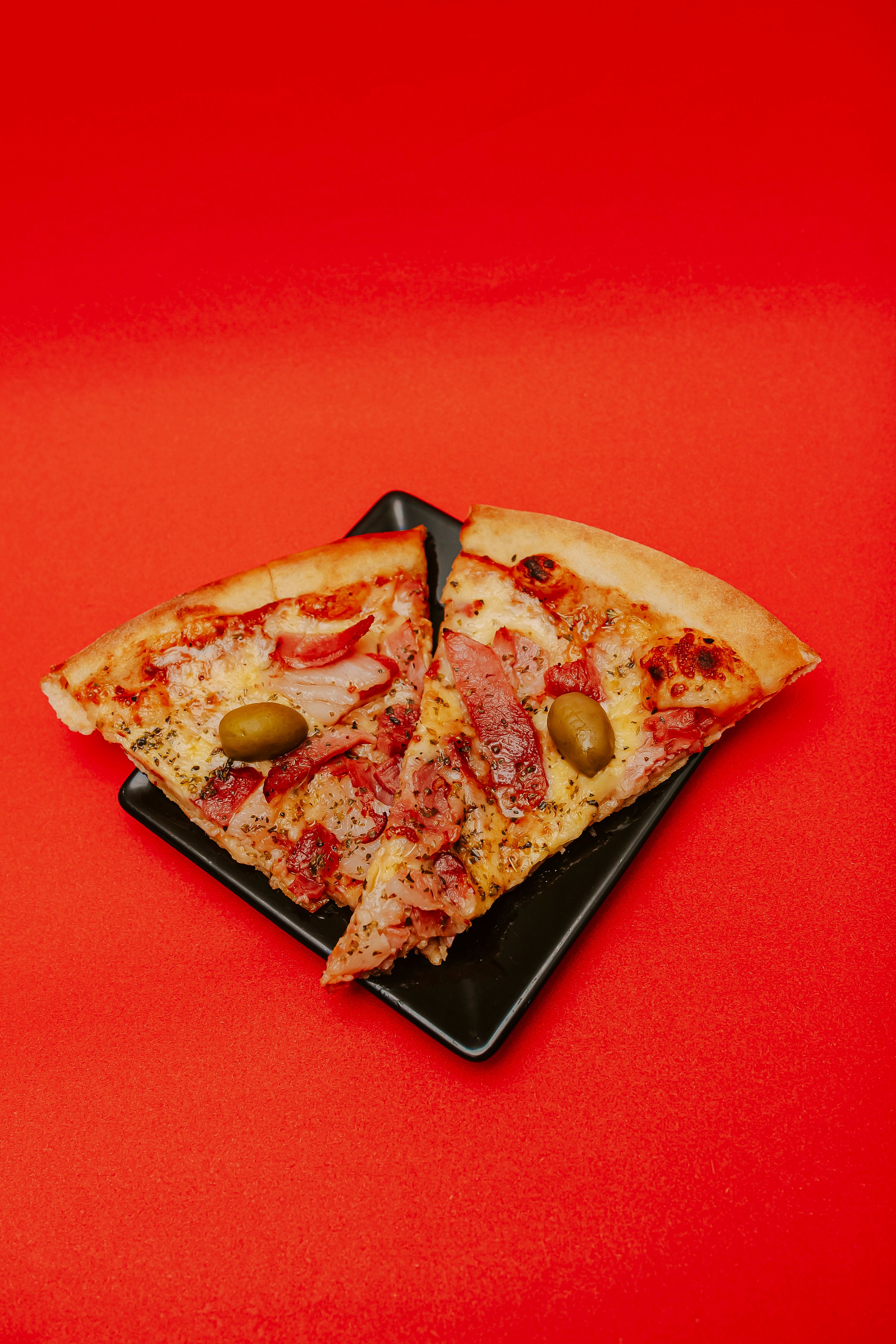 Delicious Pepperoni Pizza Slices on Red Background · Free Stock Photo