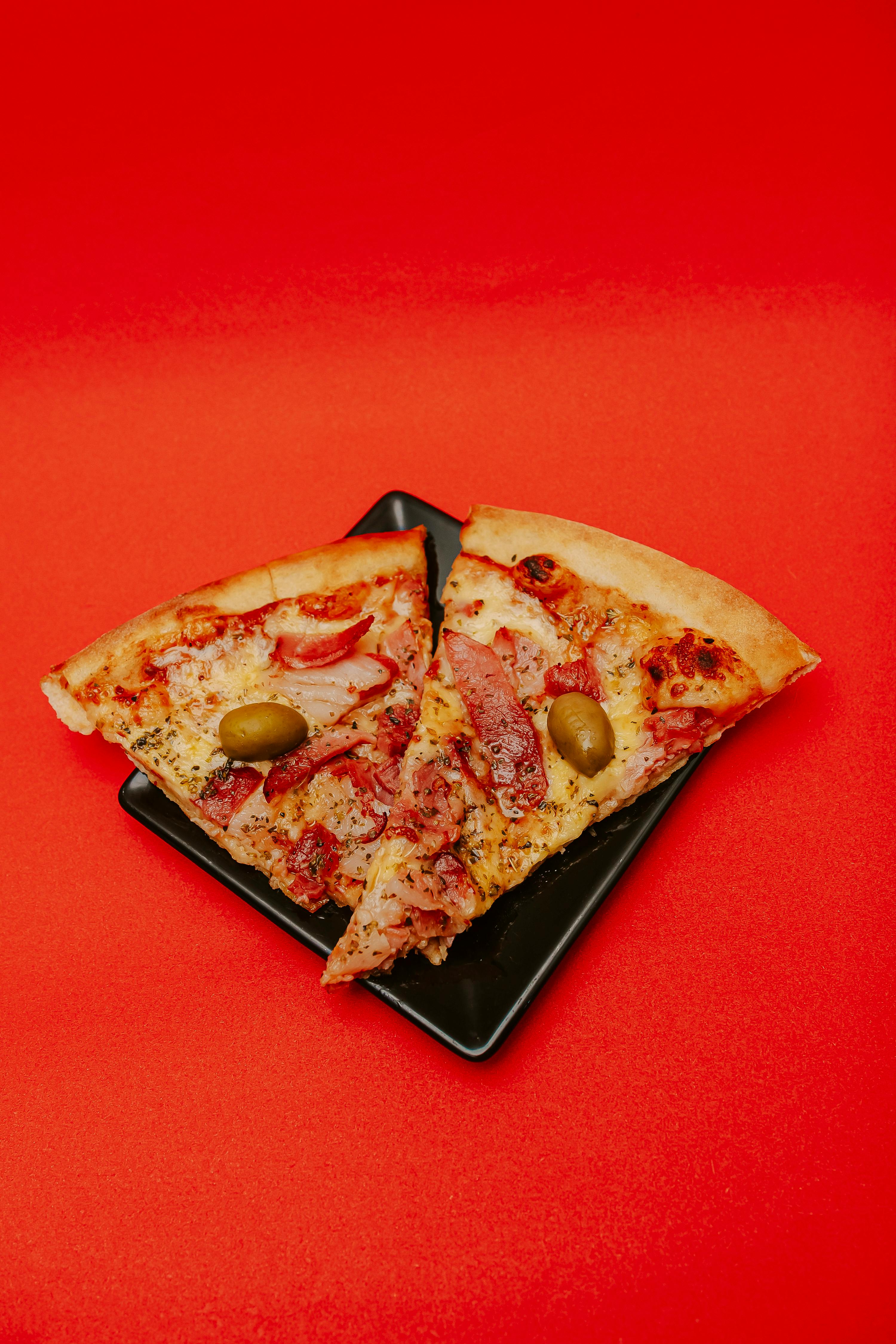 Delicious Pepperoni Pizza Slices on Red Background · Free Stock Photo