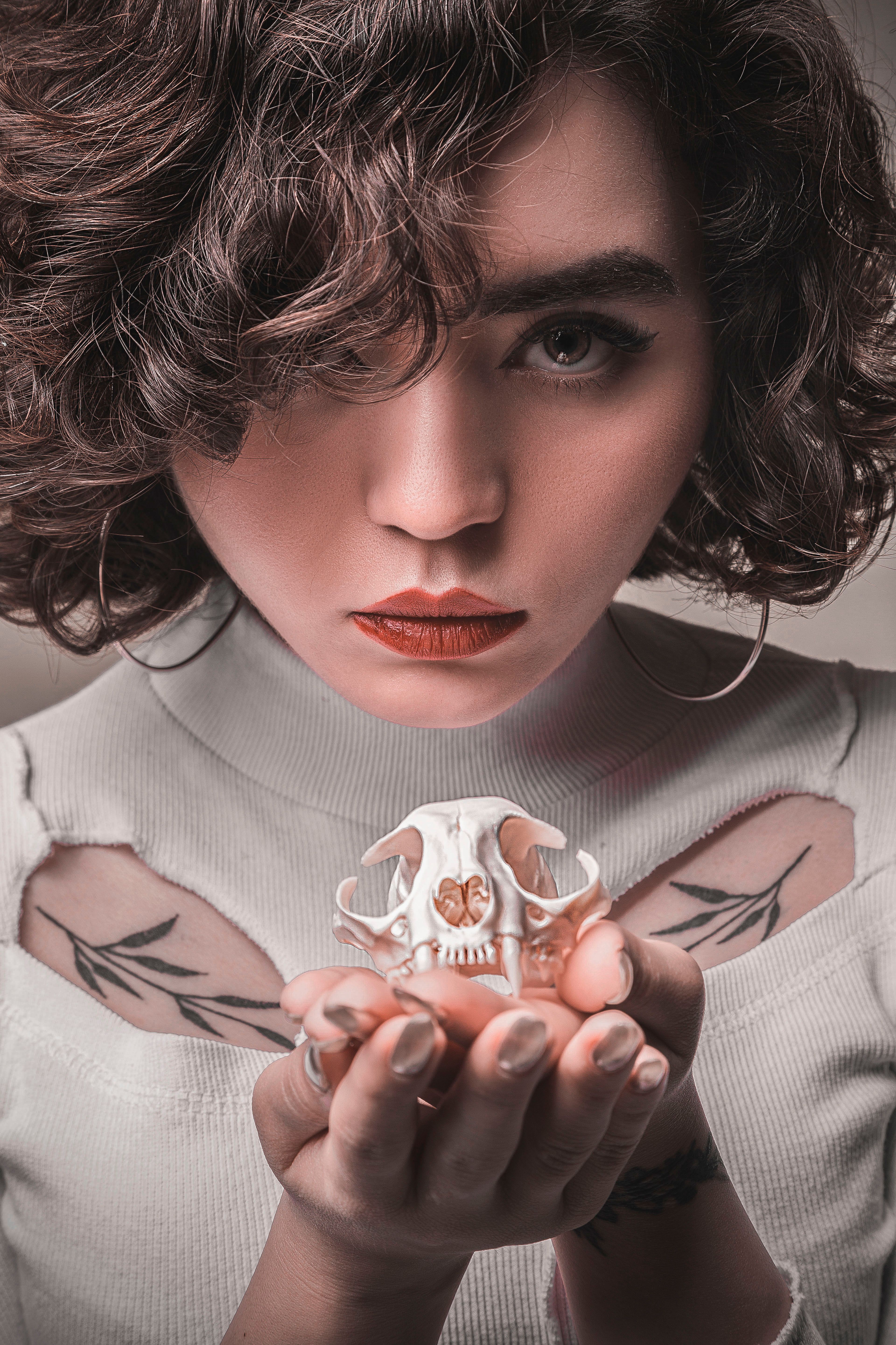 Moody Portrait with Animal Skull and Curly Hair · Free Stock Photo