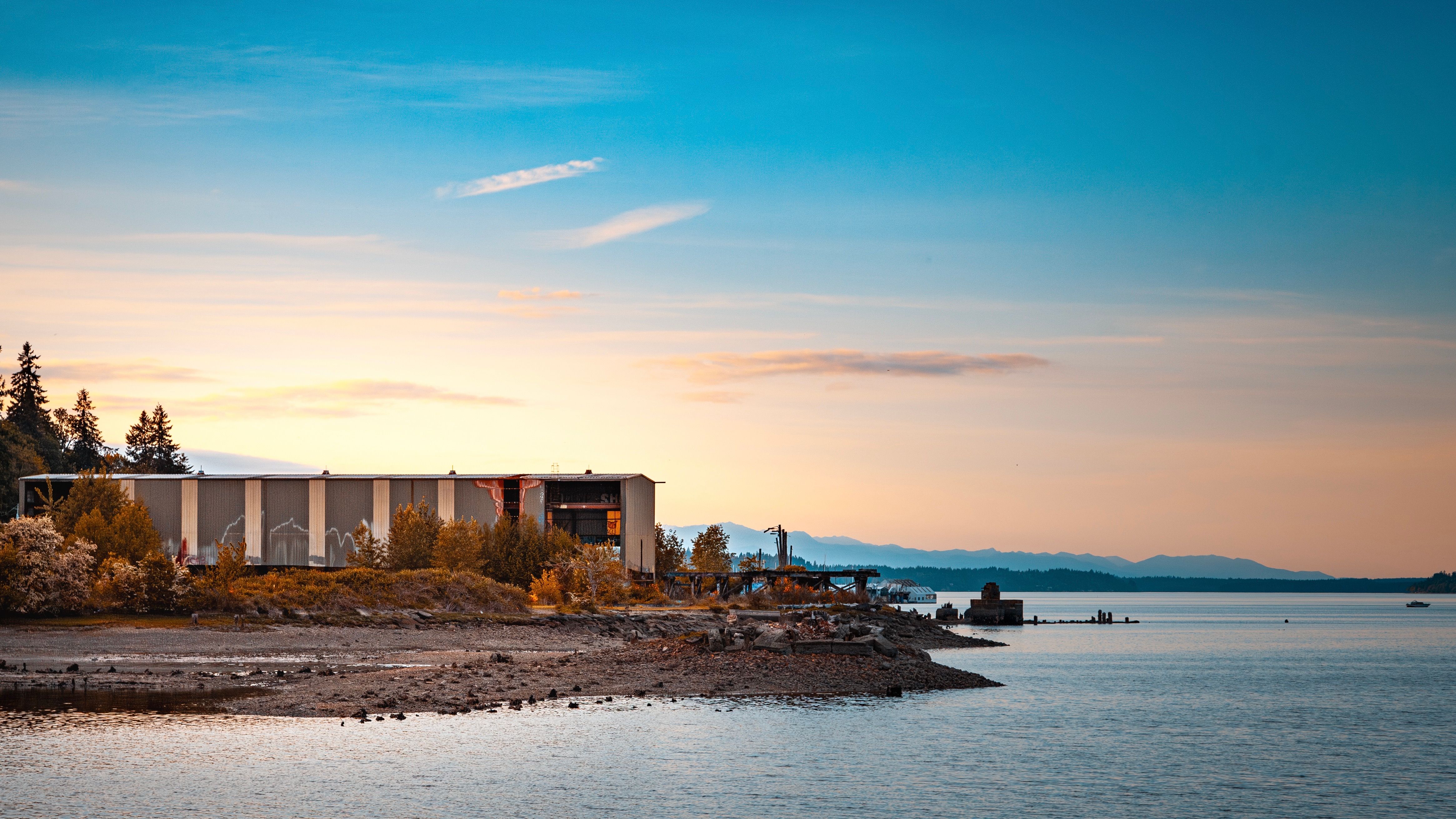 Abandoned Building by Tranquil Waters at Sunset · Free Stock Photo