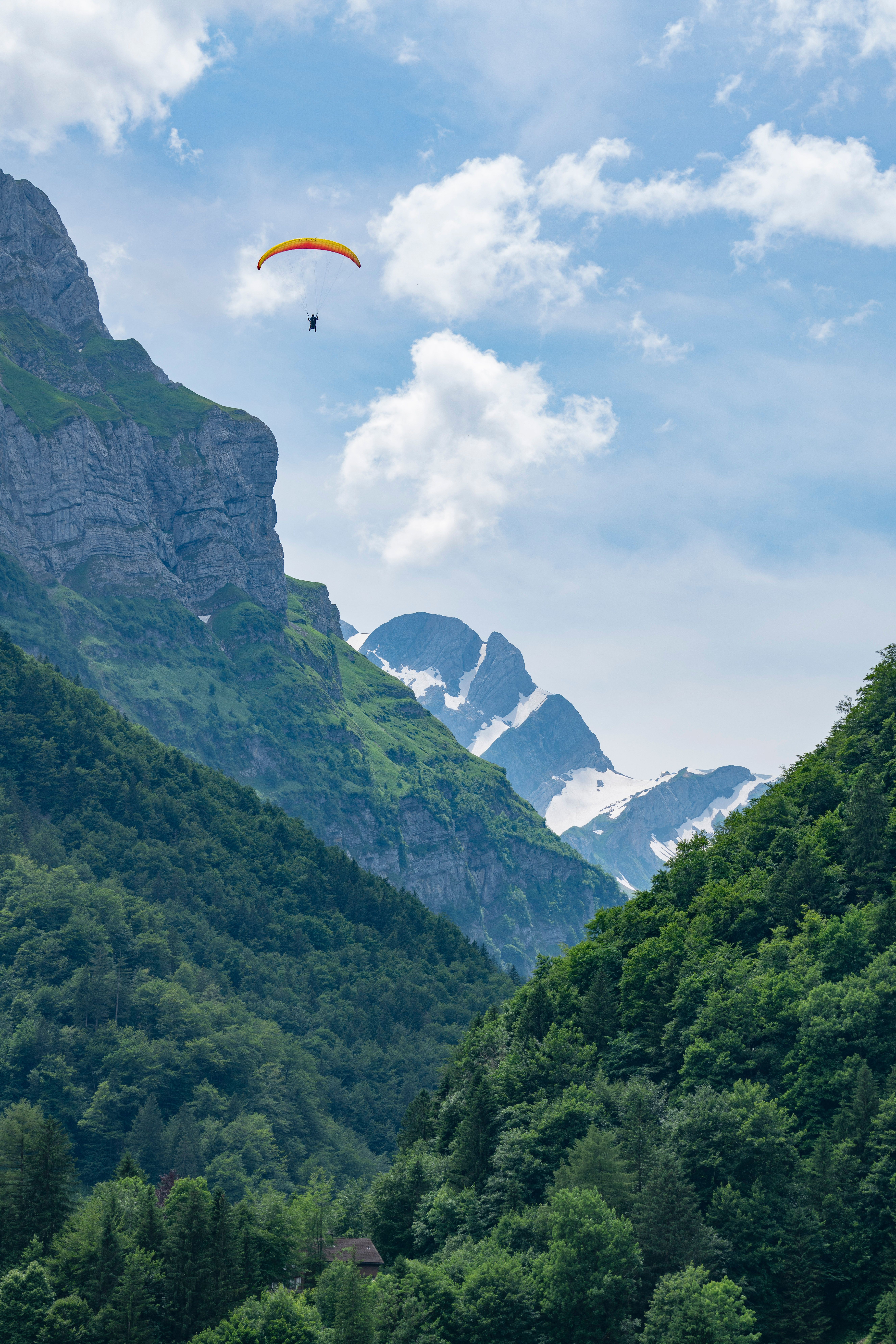 Paraglider over Scenic Mountain Landscape · Free Stock Photo