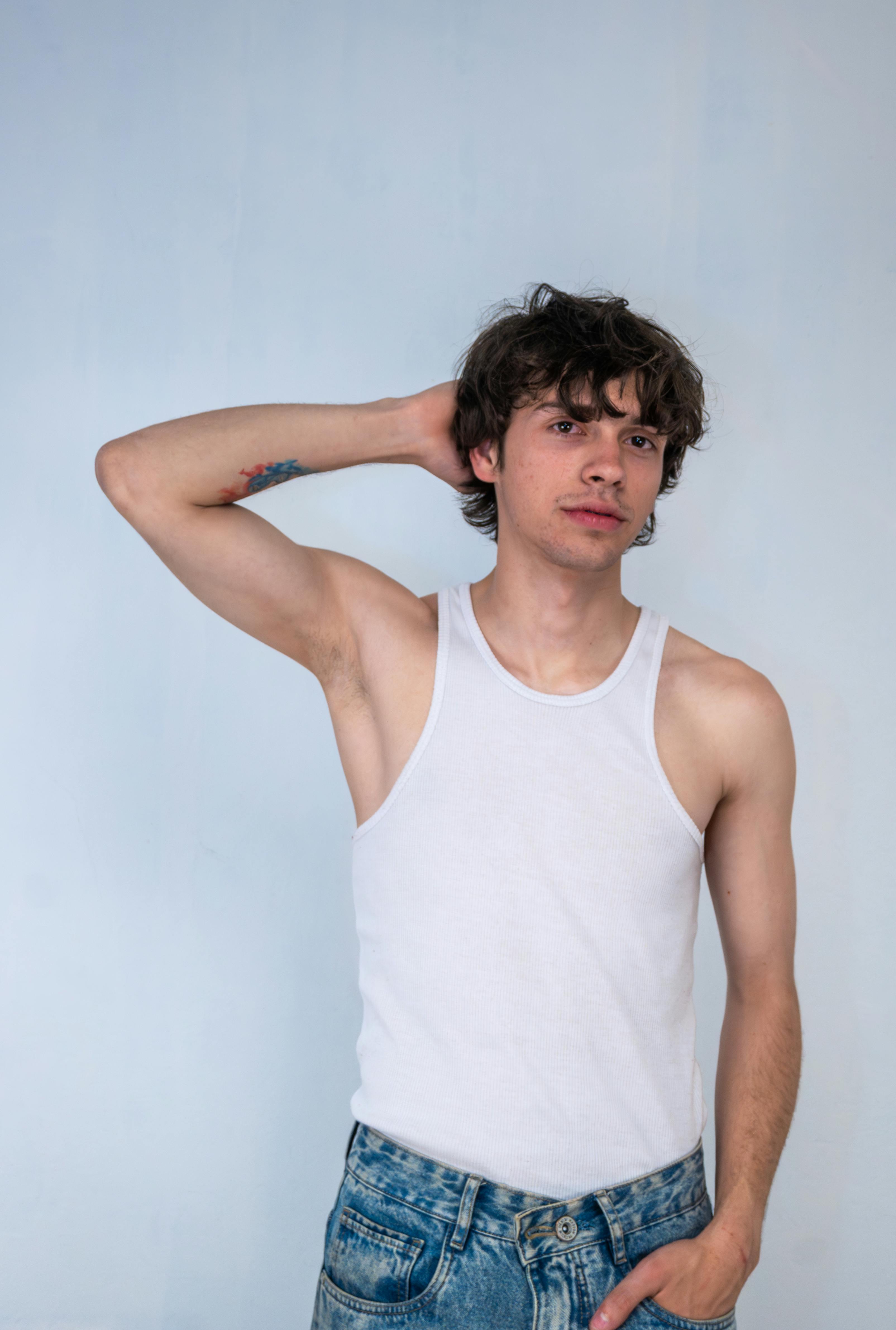 Casual Male Model in White Tank Top Posing · Free Stock Photo