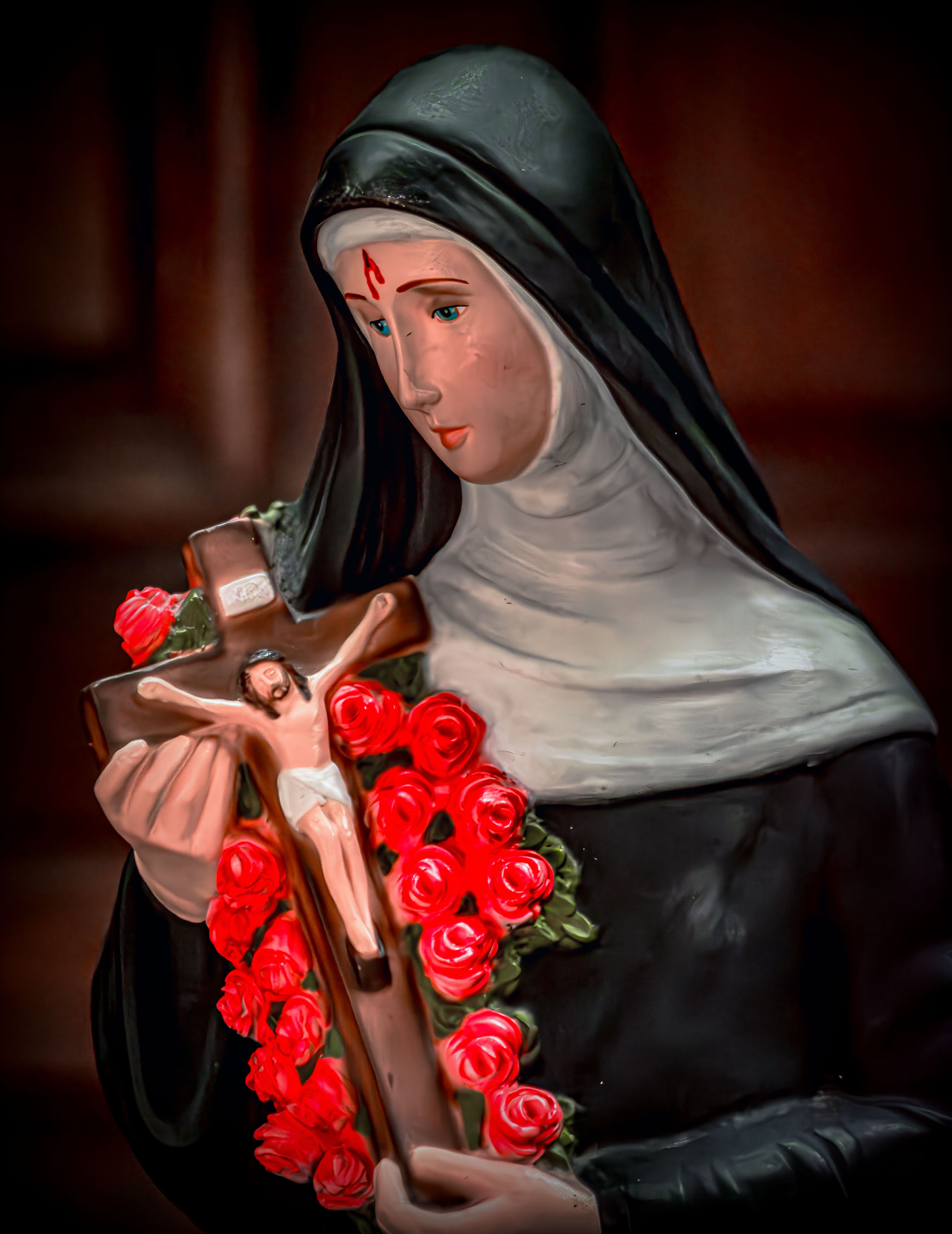 Religious Statue of Nun Holding Crucifix with Roses · Free Stock Photo