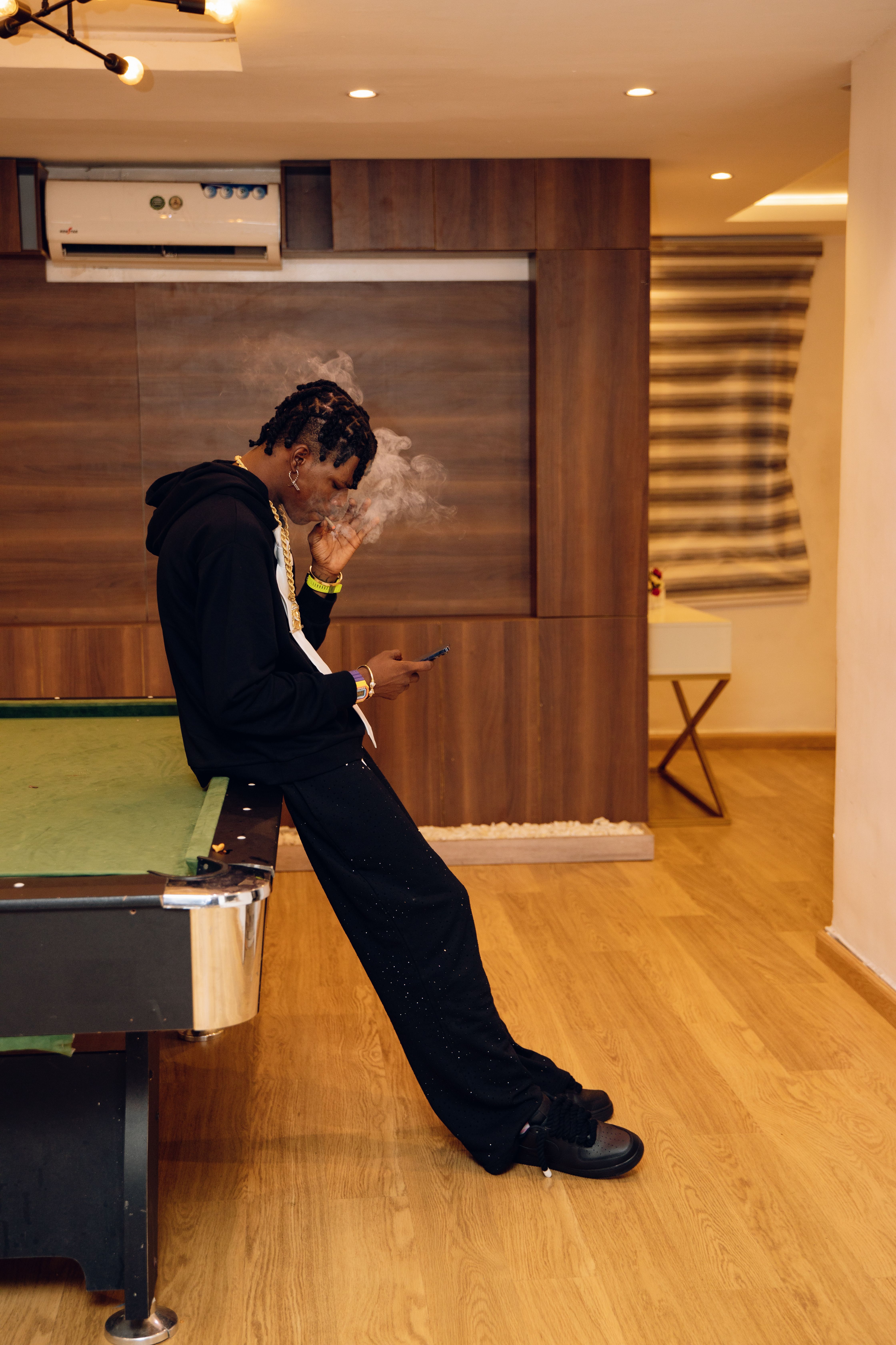 Young Man Smoking in Modern Indoor Setting · Free Stock Photo