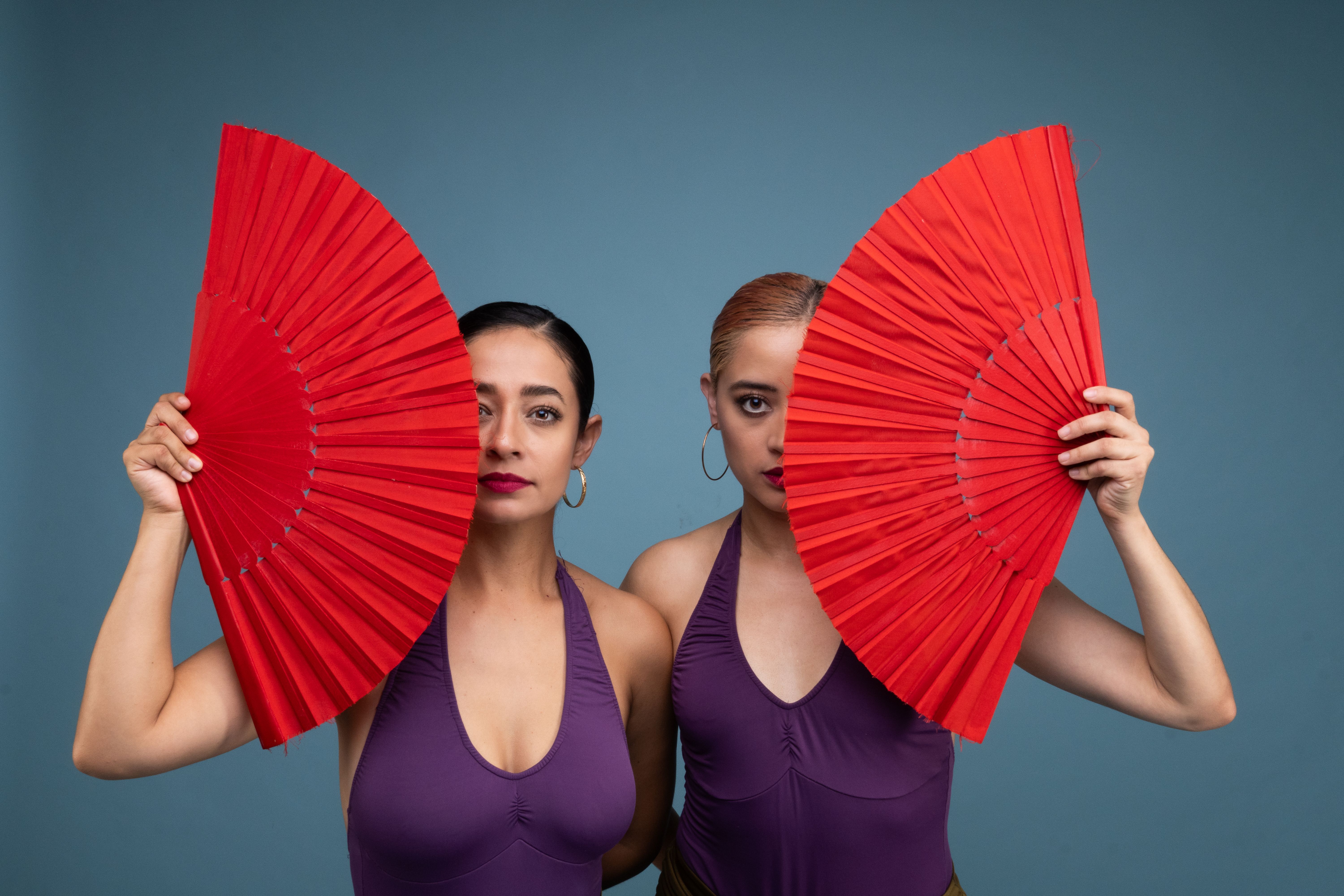 Dynamic Portrait of Two Elegant Dancers with Fans · Free Stock Photo