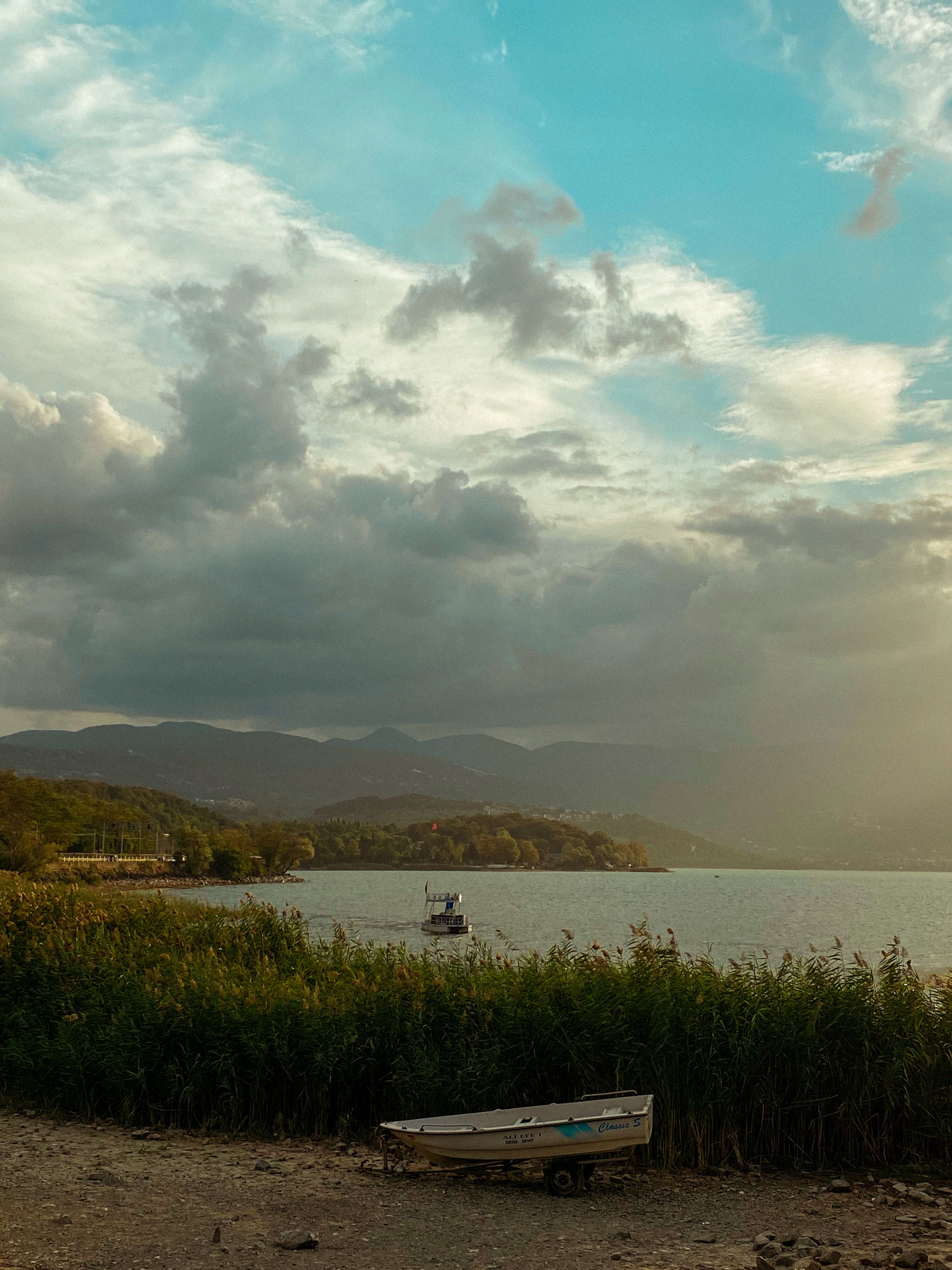 Serene Lakeside at Sunset with Scenic Mountains · Free Stock Photo