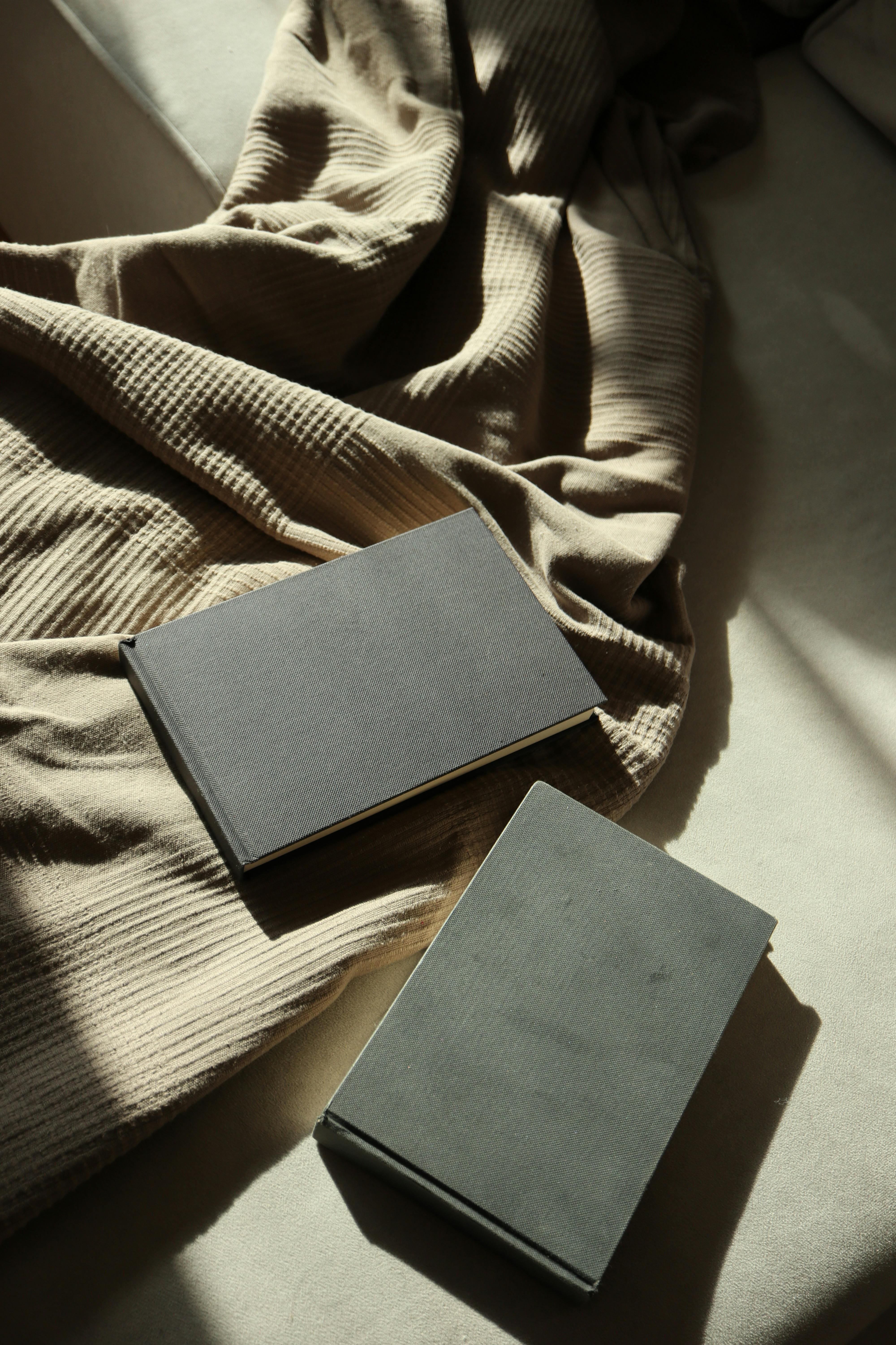 Minimalist Notebook Display on Soft Beige Fabric · Free Stock Photo