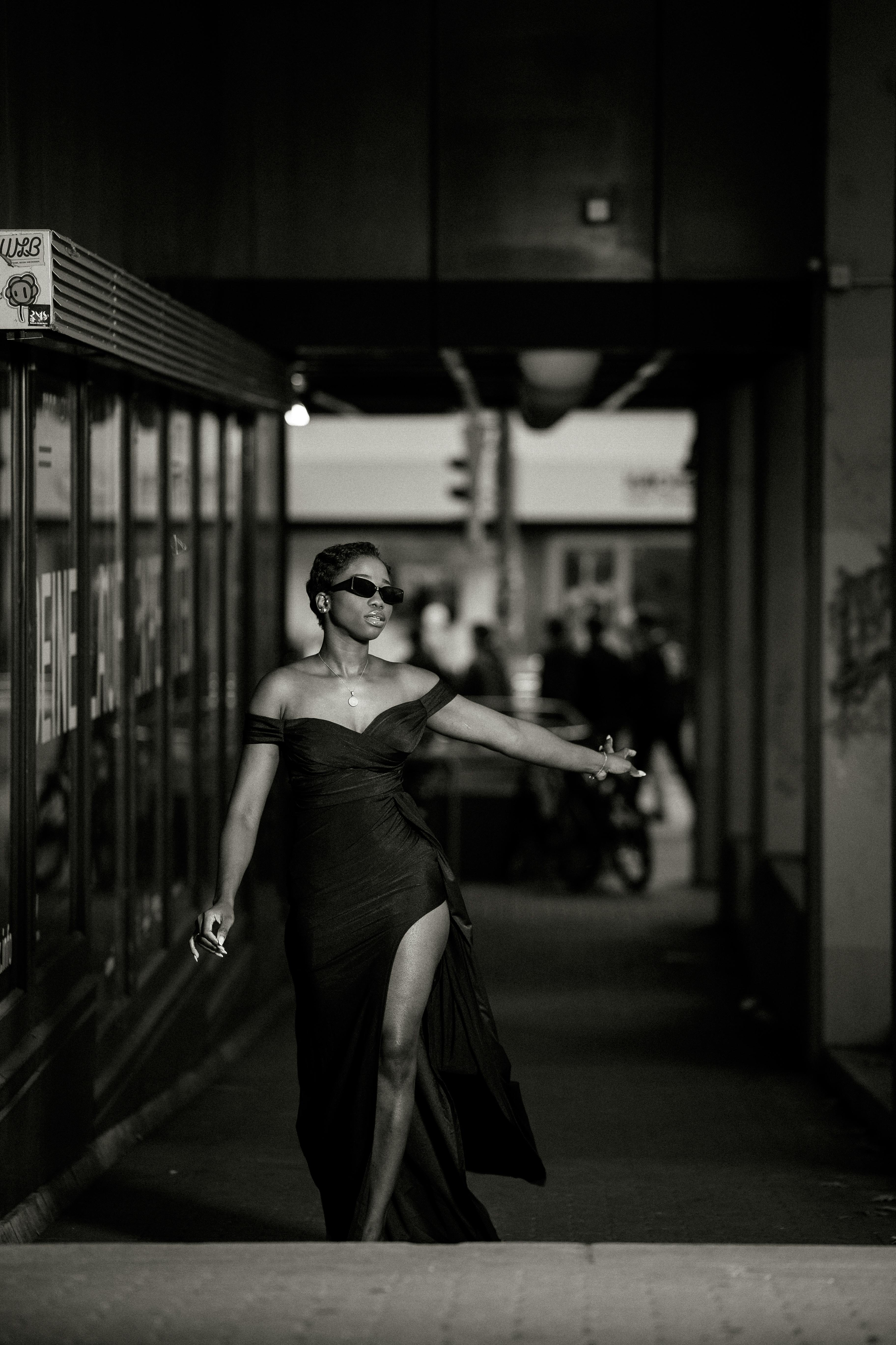 Elegant Woman Walking in Urban Alleyway · Free Stock Photo