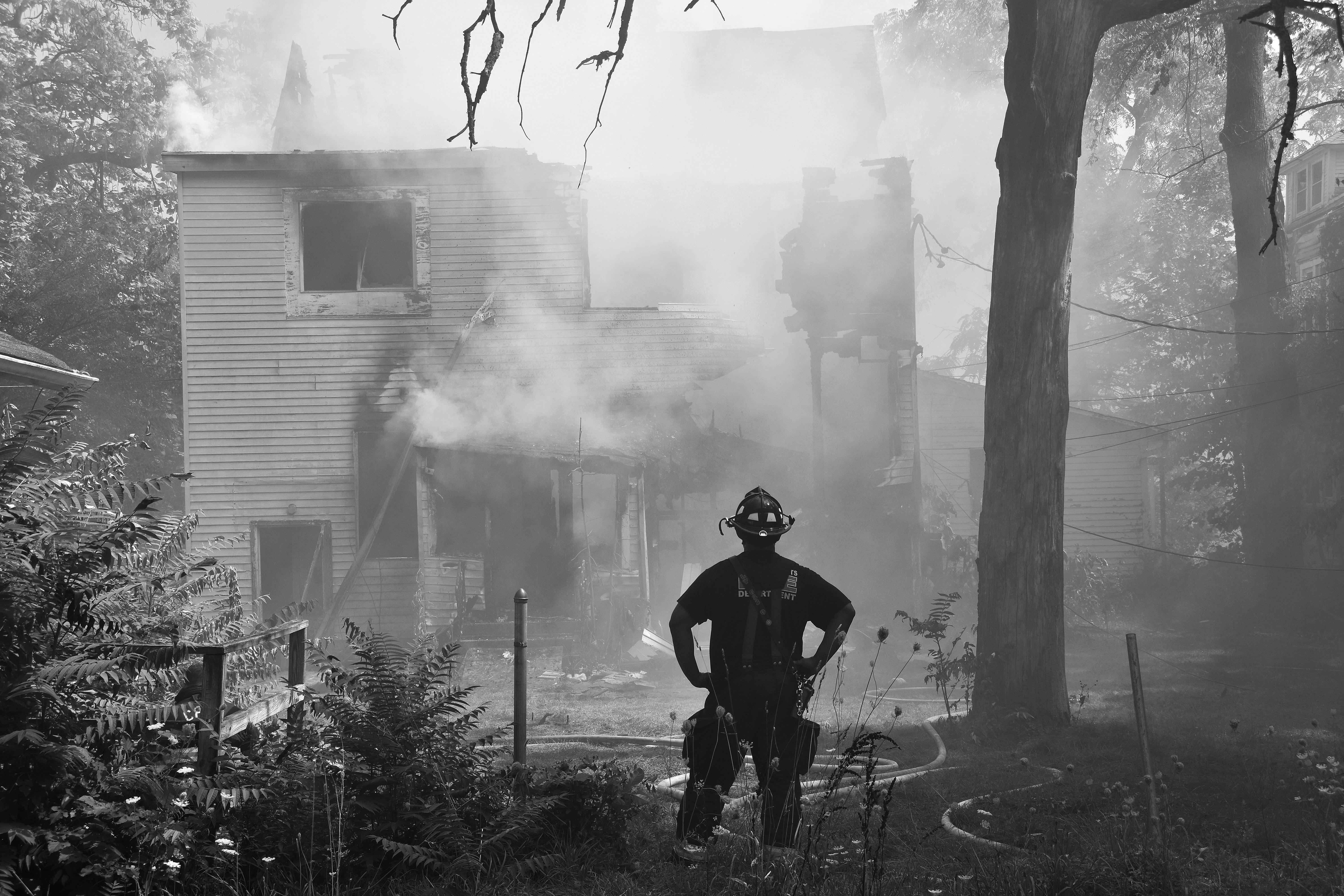 Fire Fighter Wearing Black and Yellow Uniform Pointing for Something ...