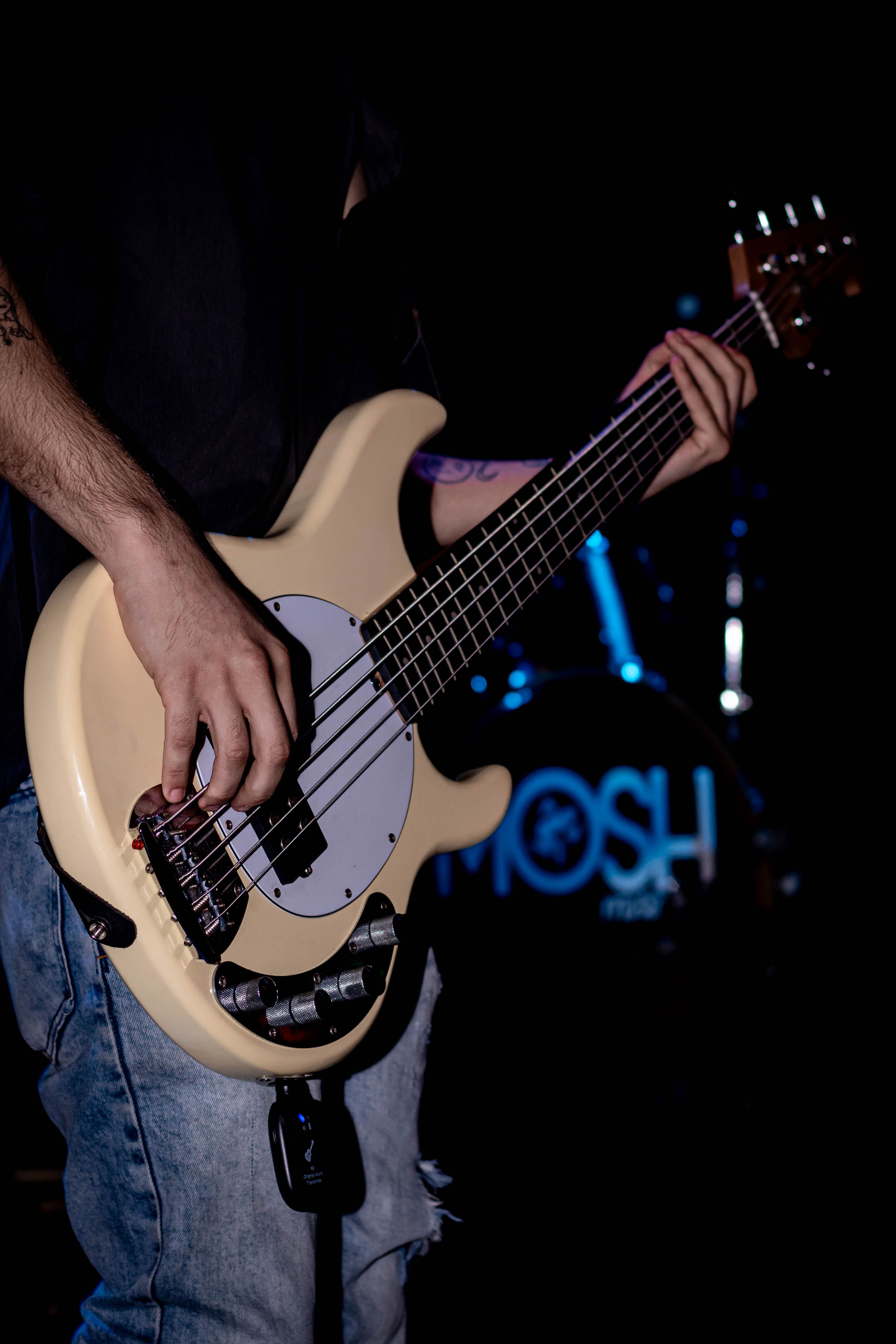Close-up of Musician Playing Bass Guitar Onstage · Free Stock Photo