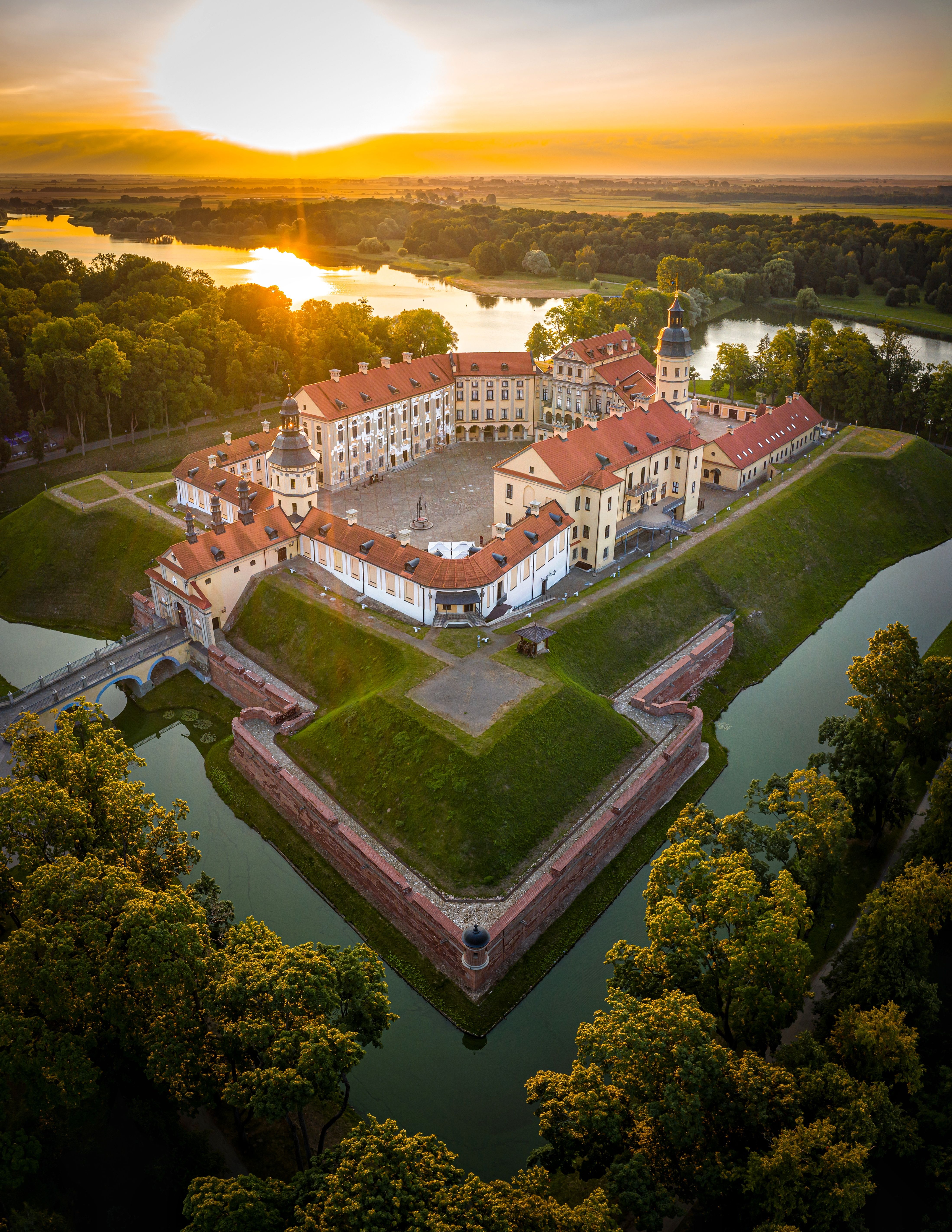 Stunning Aerial View of Historical Castle at Sunset · Free Stock Photo