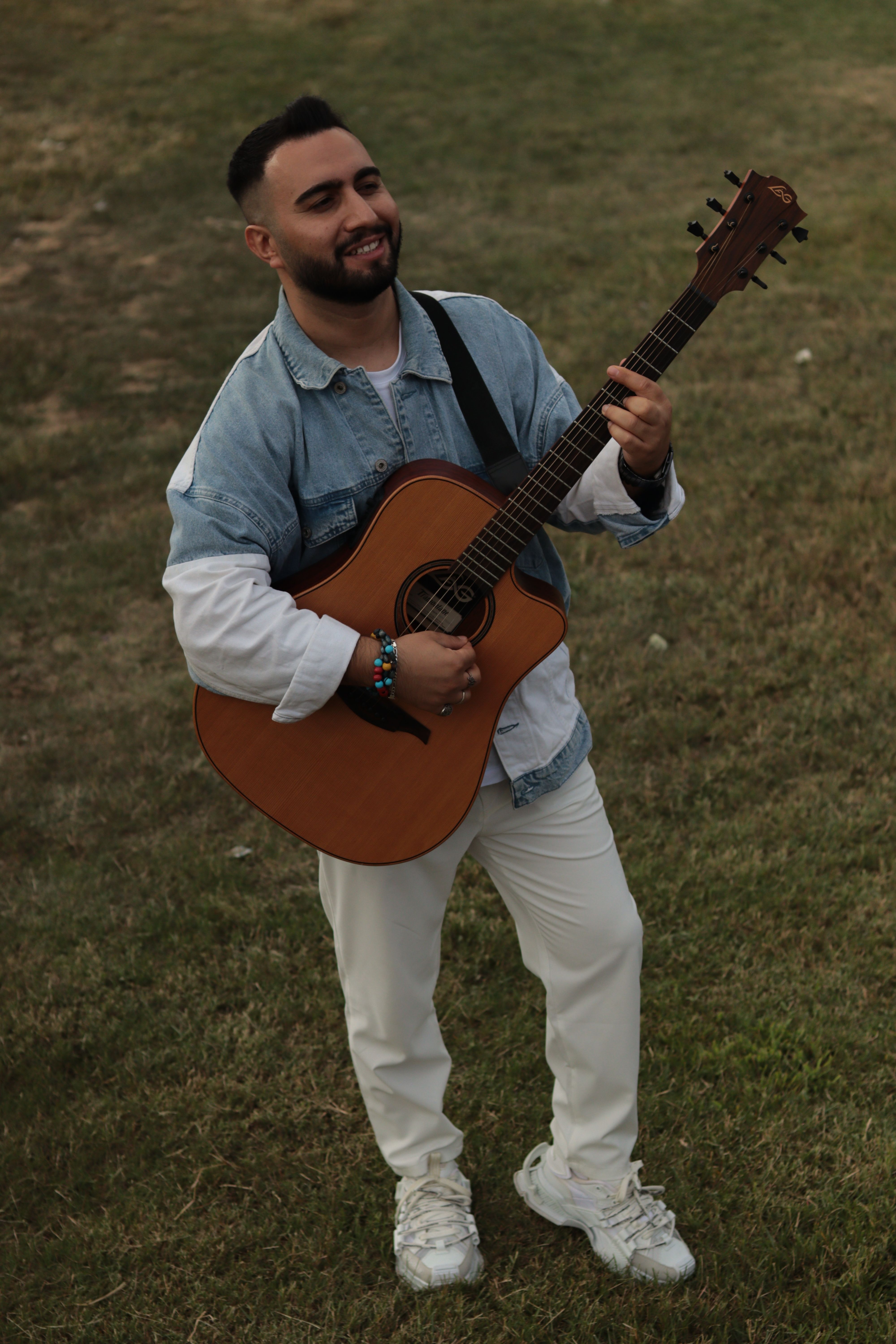 Man Playing Acoustic Guitar Outdoors in Casual Outfit · Free Stock Photo