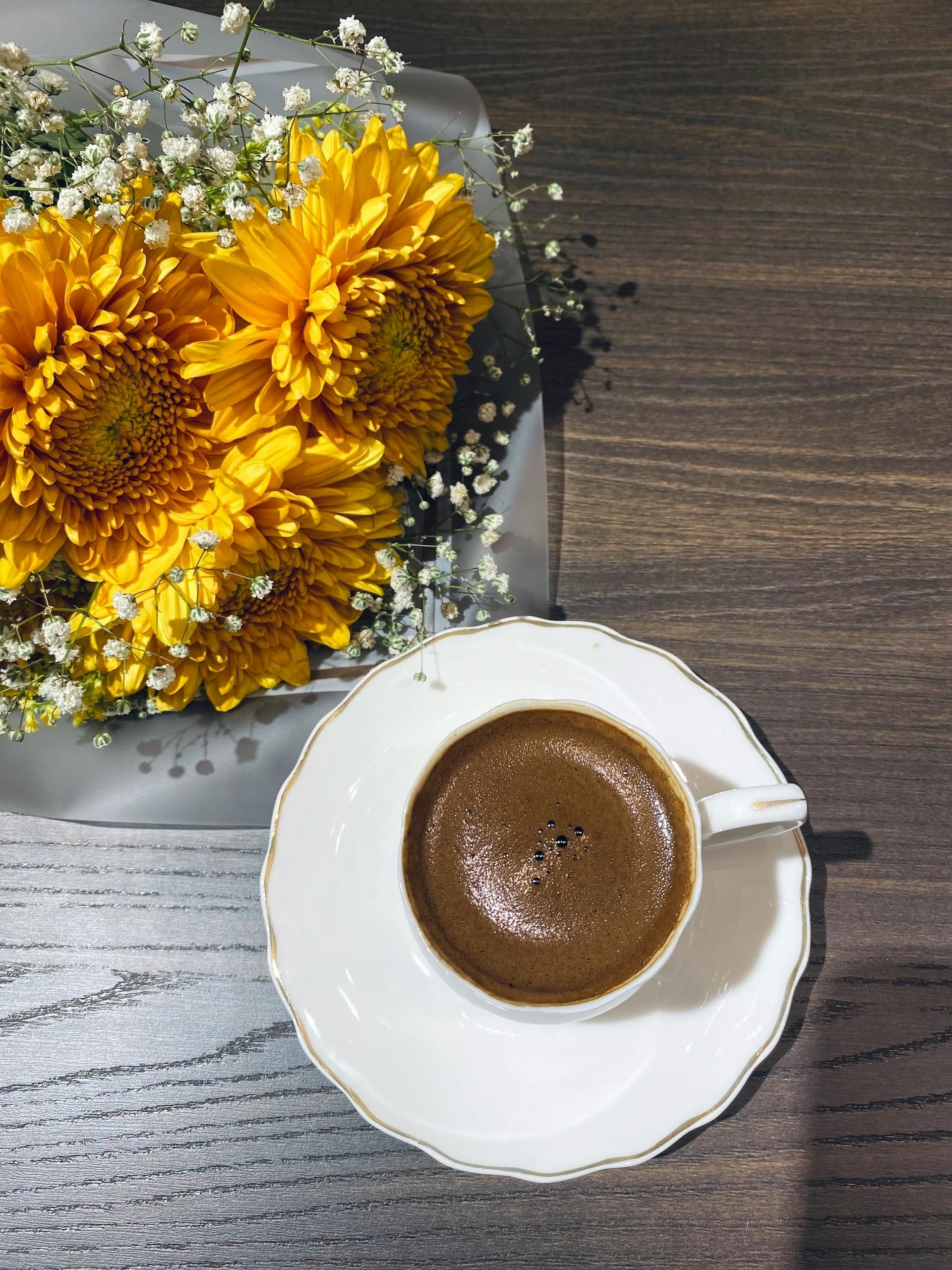 Charming Coffee and Yellow Flower Arrangement · Free Stock Photo