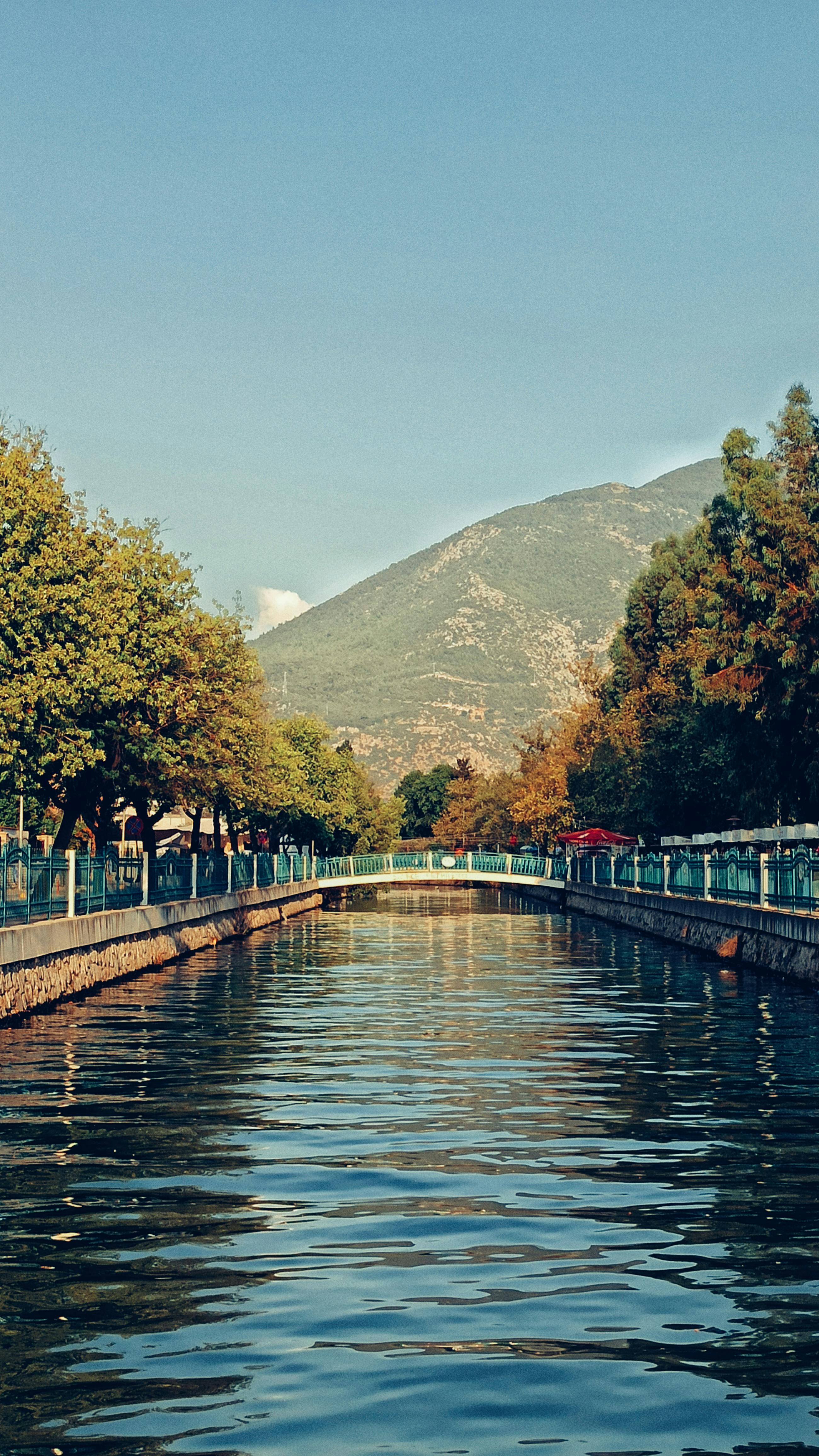 Scenic Mountain Canal with Trees and Blue Sky · Free Stock Photo