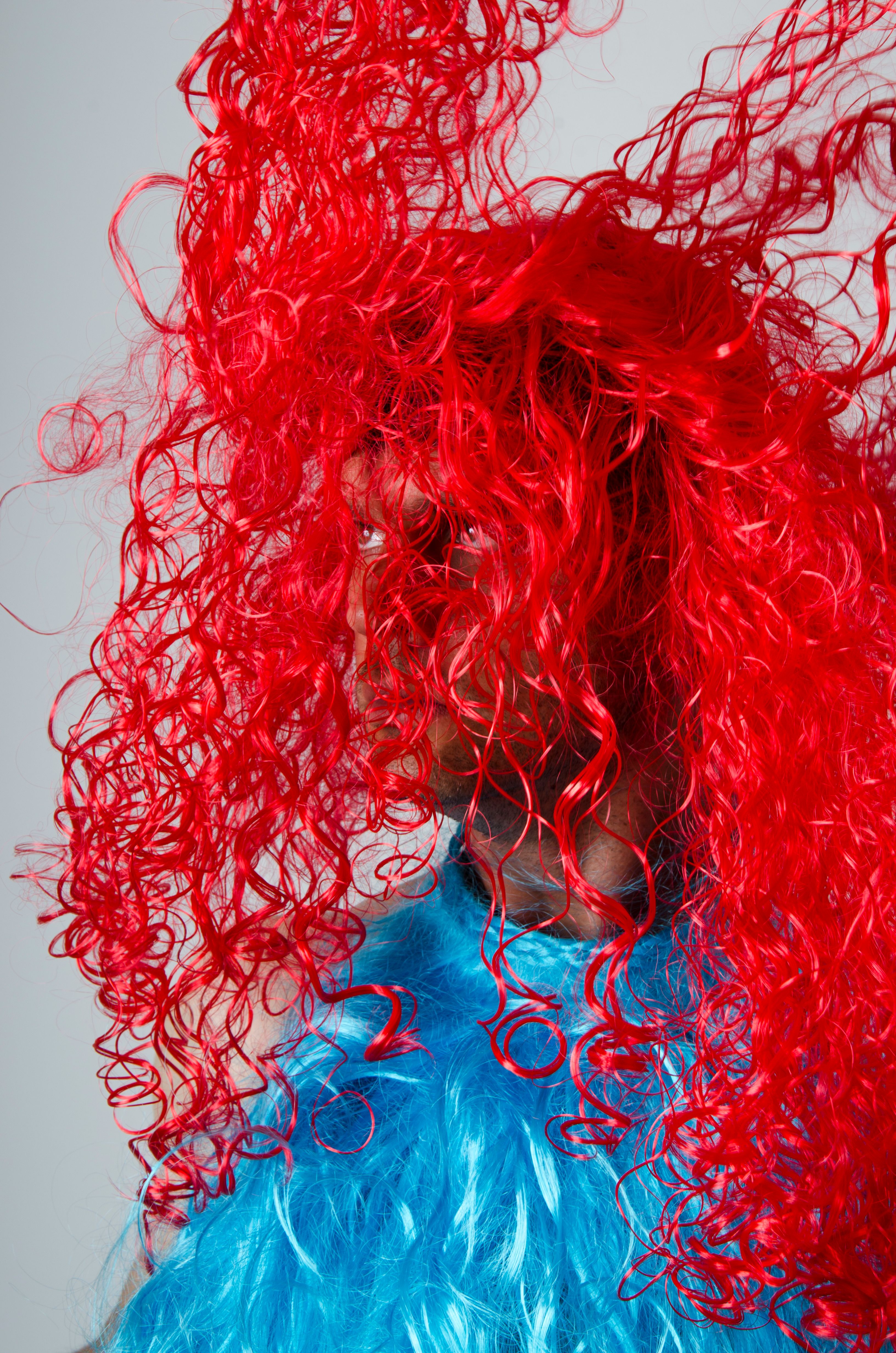 Vibrant Portrait with Red Curly Hair and Blue Fur · Free Stock Photo