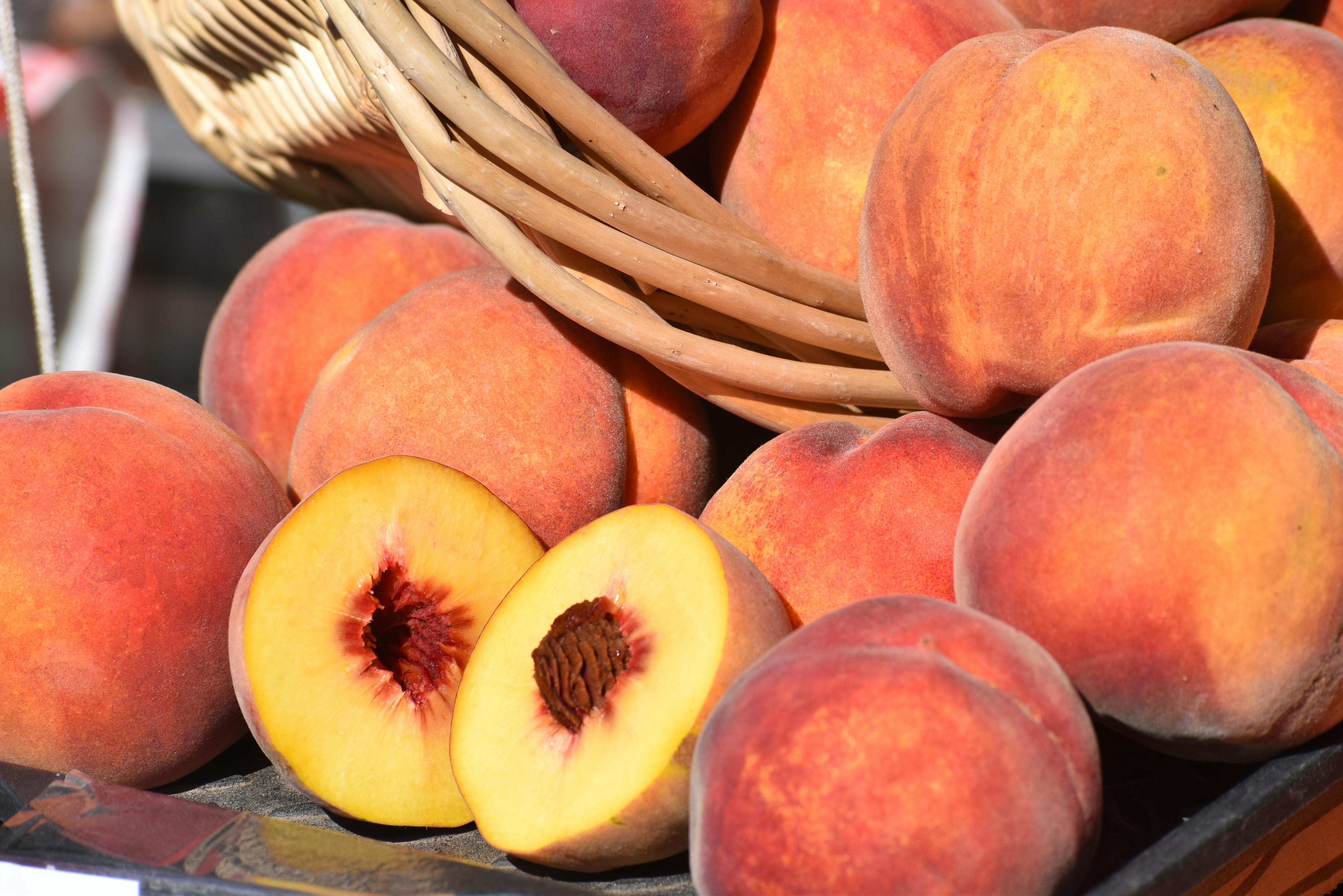 Fresh Ripe Peaches in a Rustic Basket · Free Stock Photo