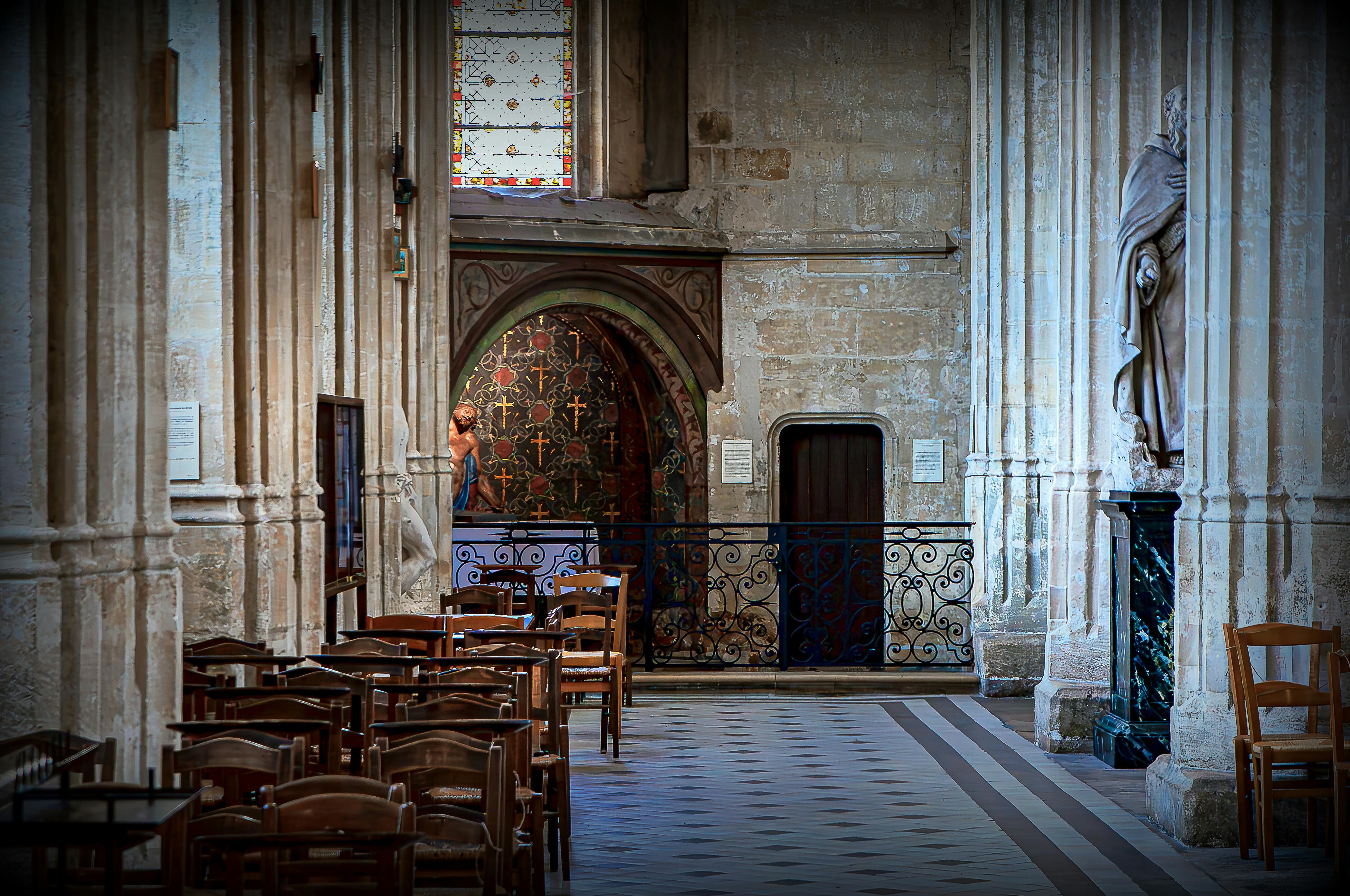Historic Church Interior with Wooden Chairs and Statue · Free Stock Photo